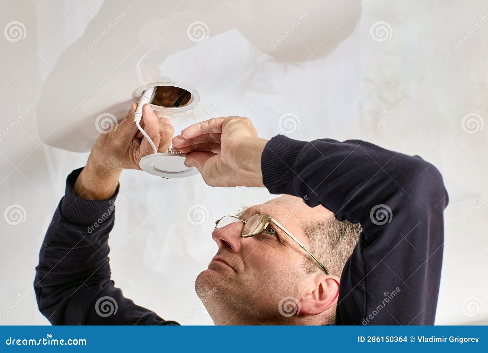 Spotlight in Stretch Suspended Ceiling is Installed in Socket after ...