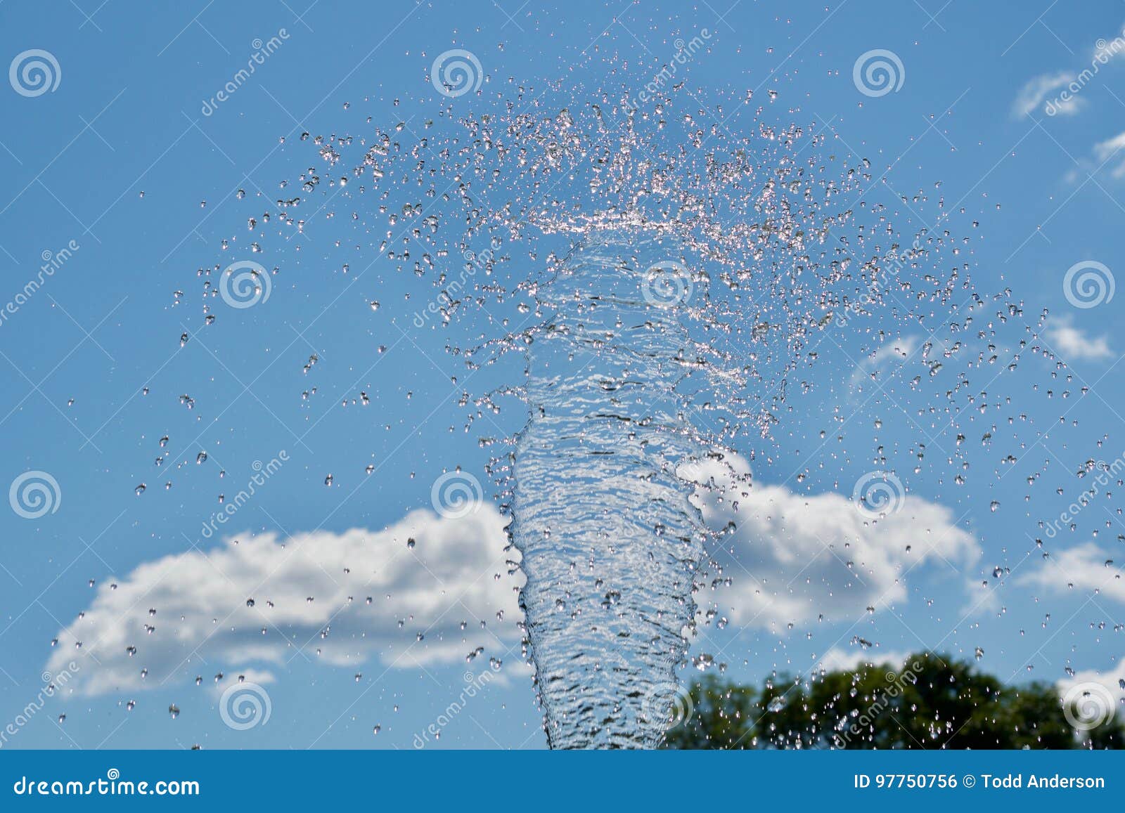 A Spray Of Water With A Blue Sky And Cloud Background Stock Photo ...