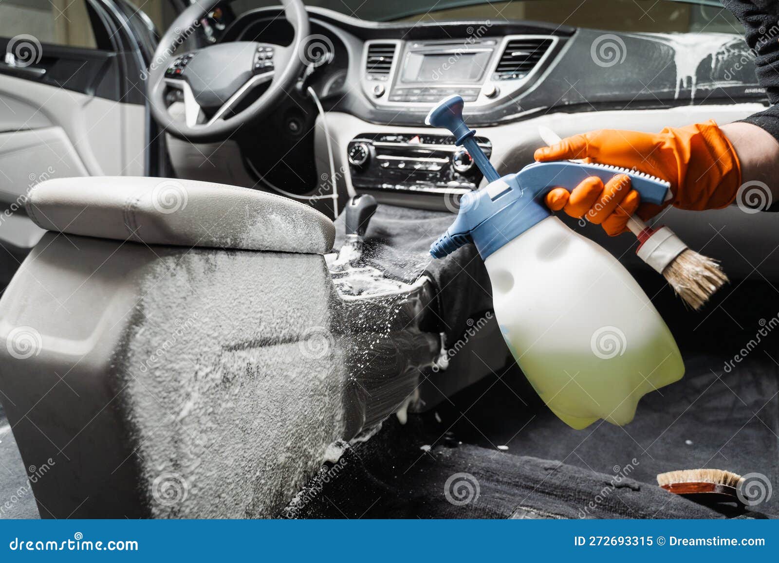 Spraying Detergent on Dashboard in Car Interior for Dry Cleaning ... Spraying Detergent on Dashboard in Car Interior for Dry Cleaning ...