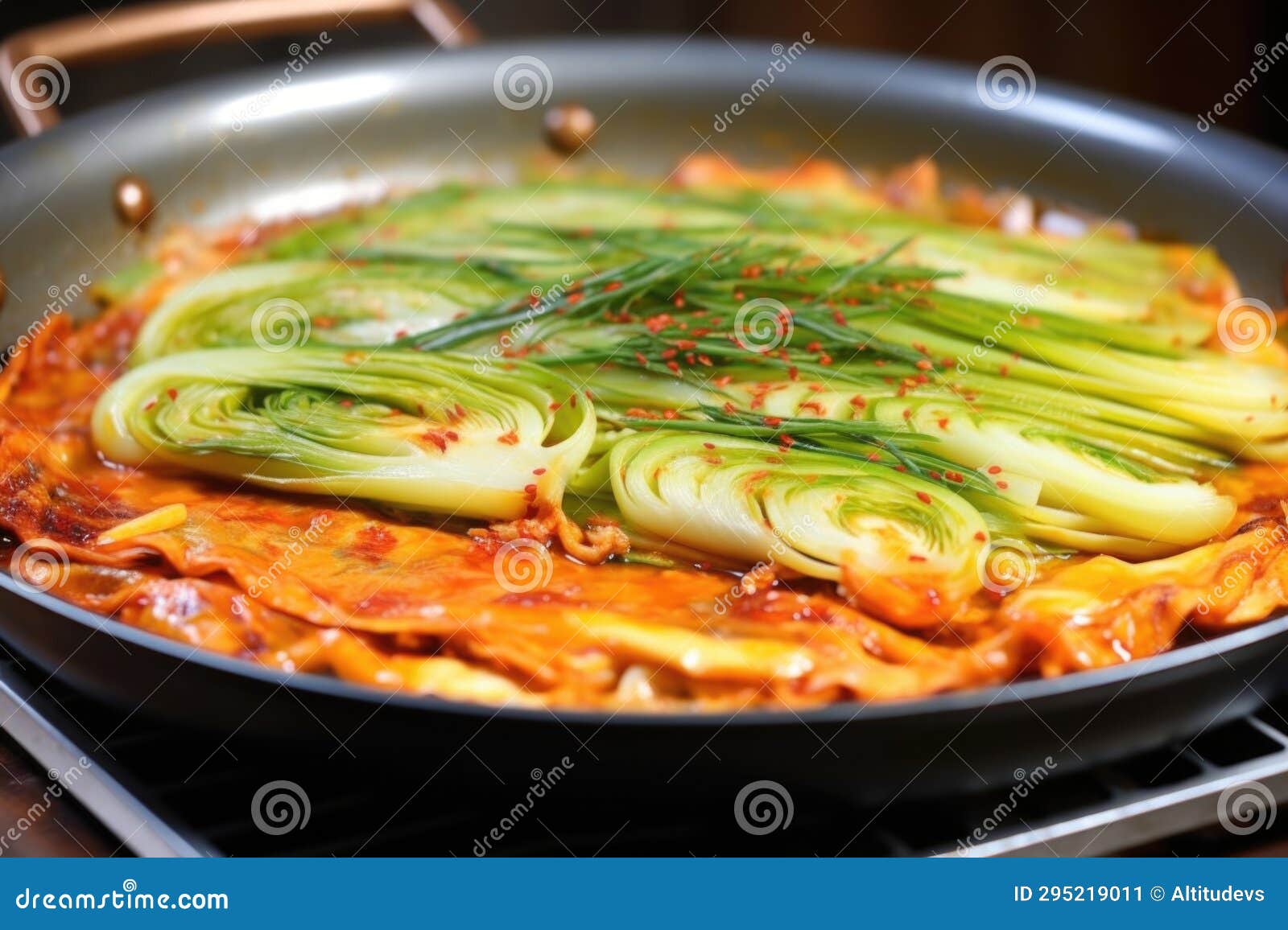 Spreading Kimchi Across an Uncooked Pancake on the Pan Stock Image ...