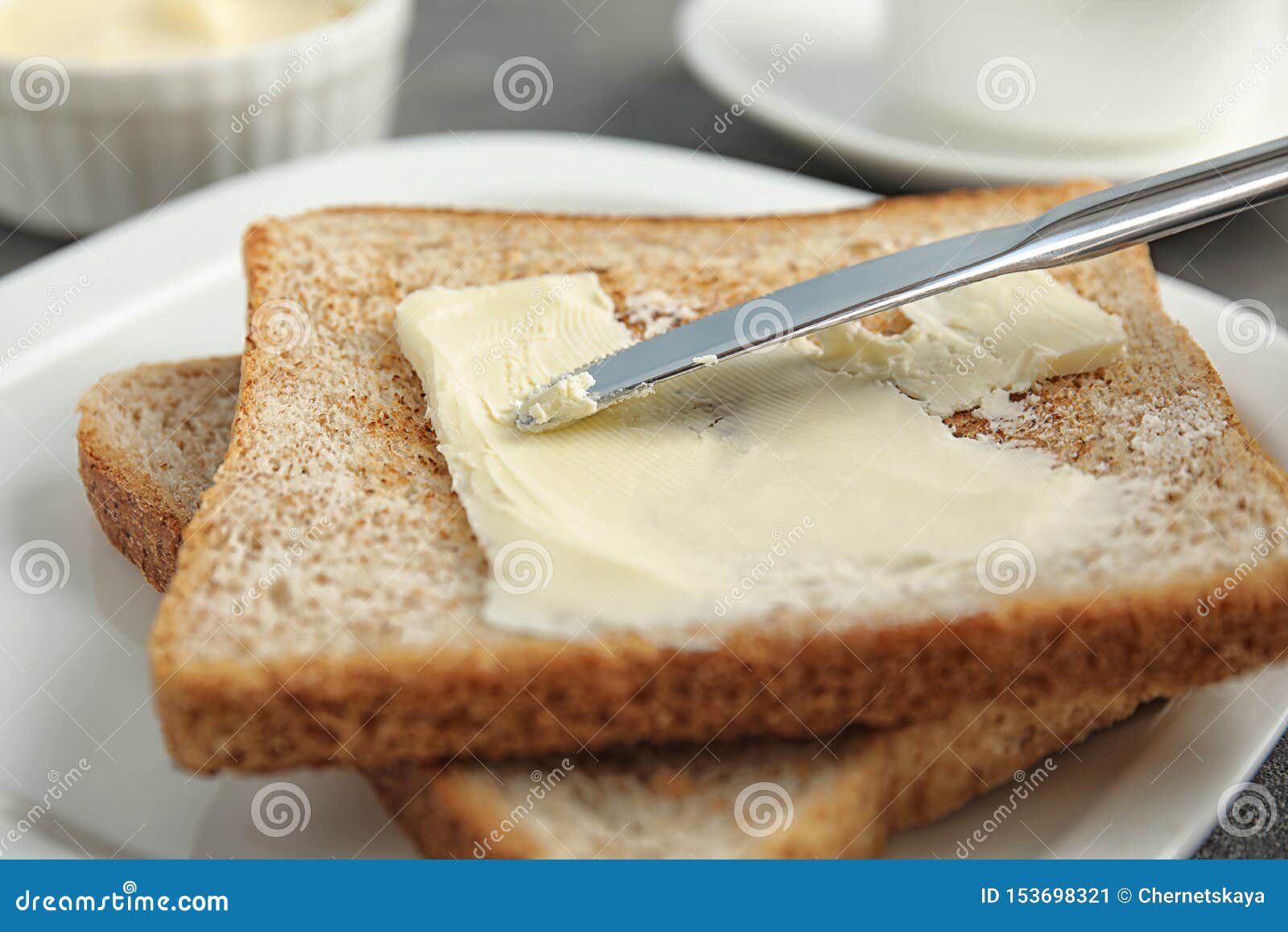 Spreading Tasty Butter Onto Slice of Bread with Knife on Plate Stock ... Spreading Tasty Butter Onto Slice of Bread with Knife on Plate Stock ...