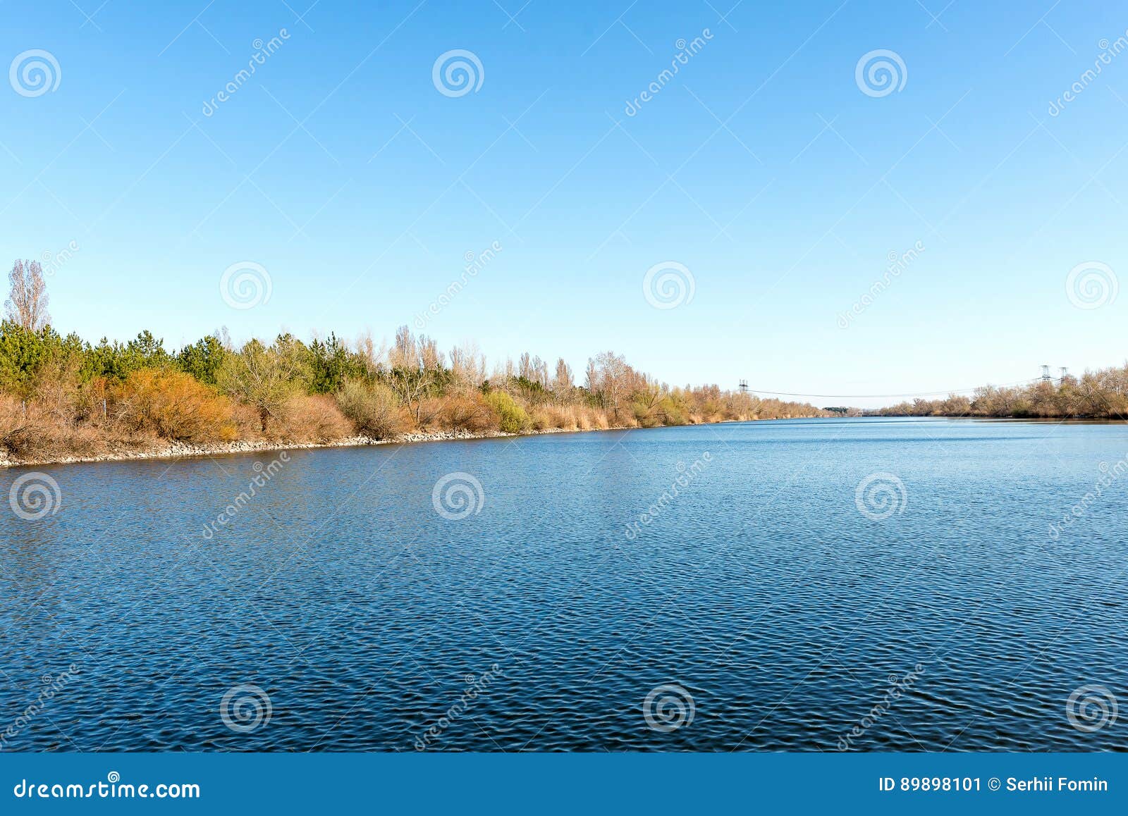 Spring Comes To the River Bank. Power Lines Above the Channels. Stock ...