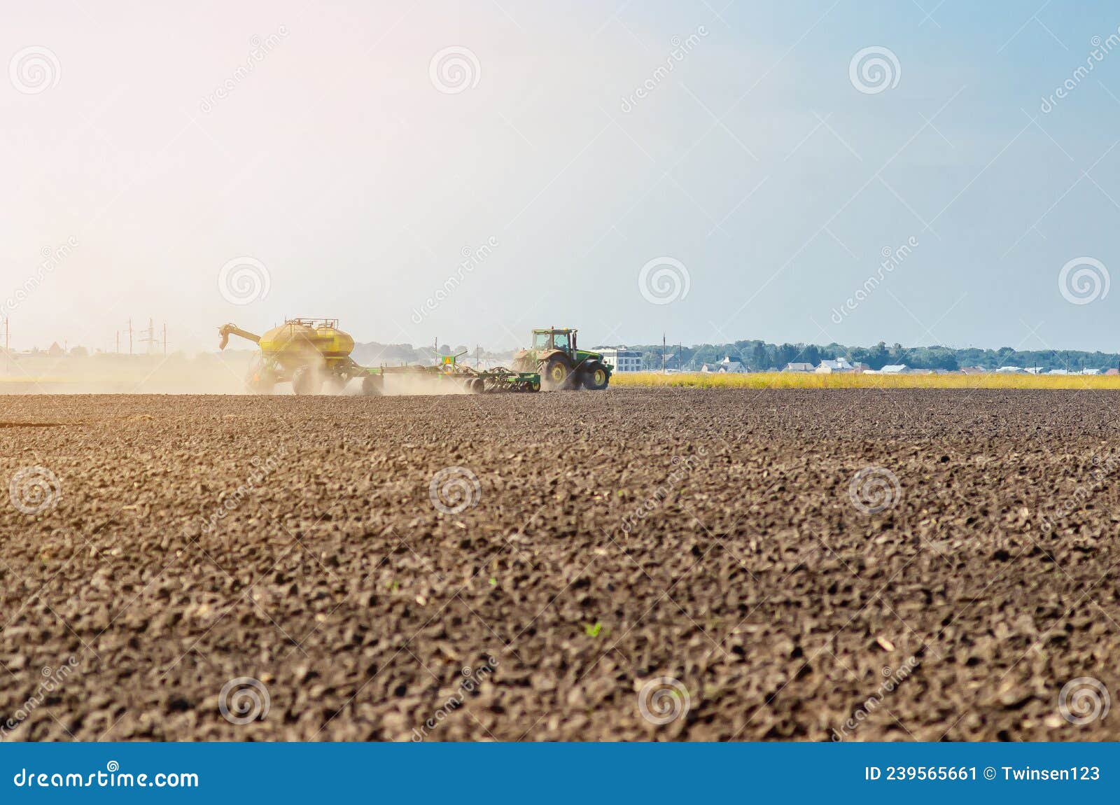 Spring Field Work. Tractor Plows the Ground in the Field. Editorial ...