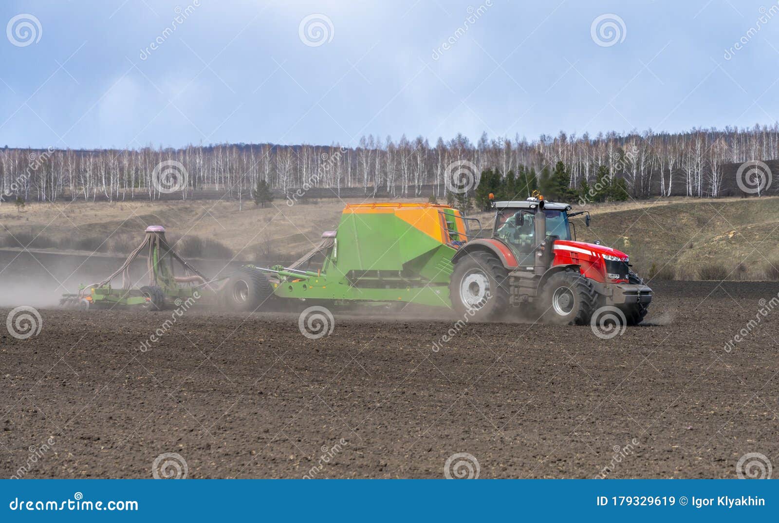 Spring Field Work, a Tractor with a Trailed Seeder Sows Seeds in an ...