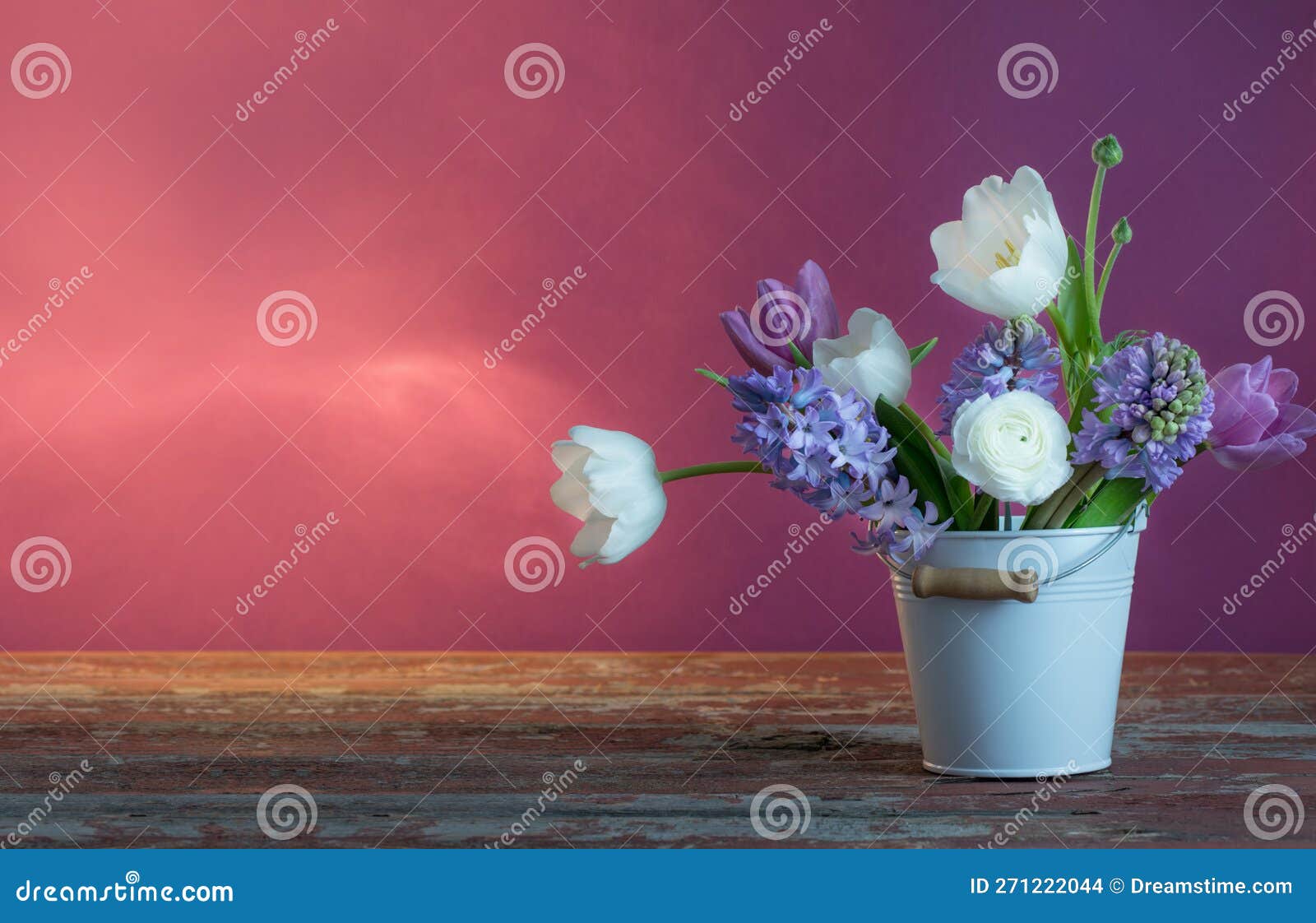 Spring Flowers in Bucket on Pink Background Stock Photo - Image of ...