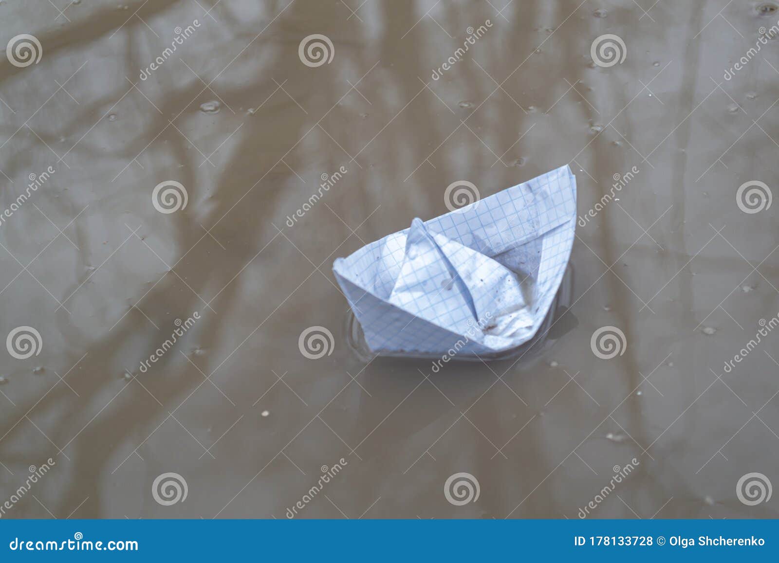 Spring Fun. Wet Paper Boat Floating in a Dirty Puddle Stock Photo ...