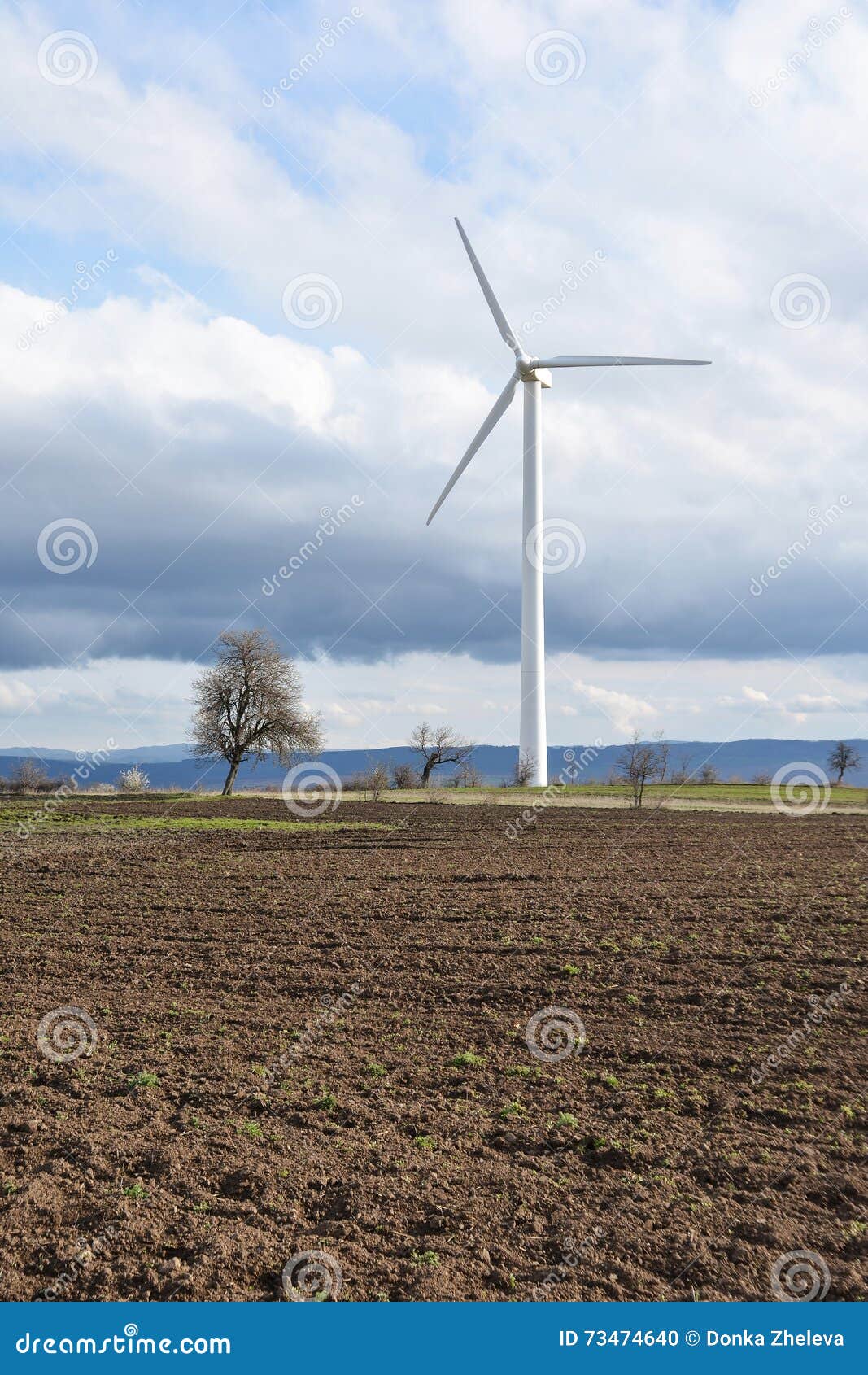 Spring Landscape with Wind Turbine Against a Cloudy Sky Stock Photo ...