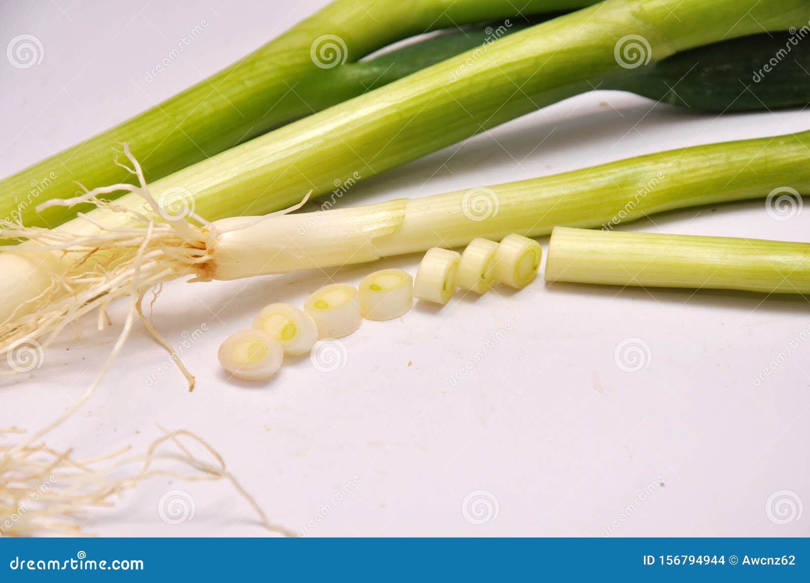 Whole and Sliced Spring Onions on a Seamless Background Stock Photo ...