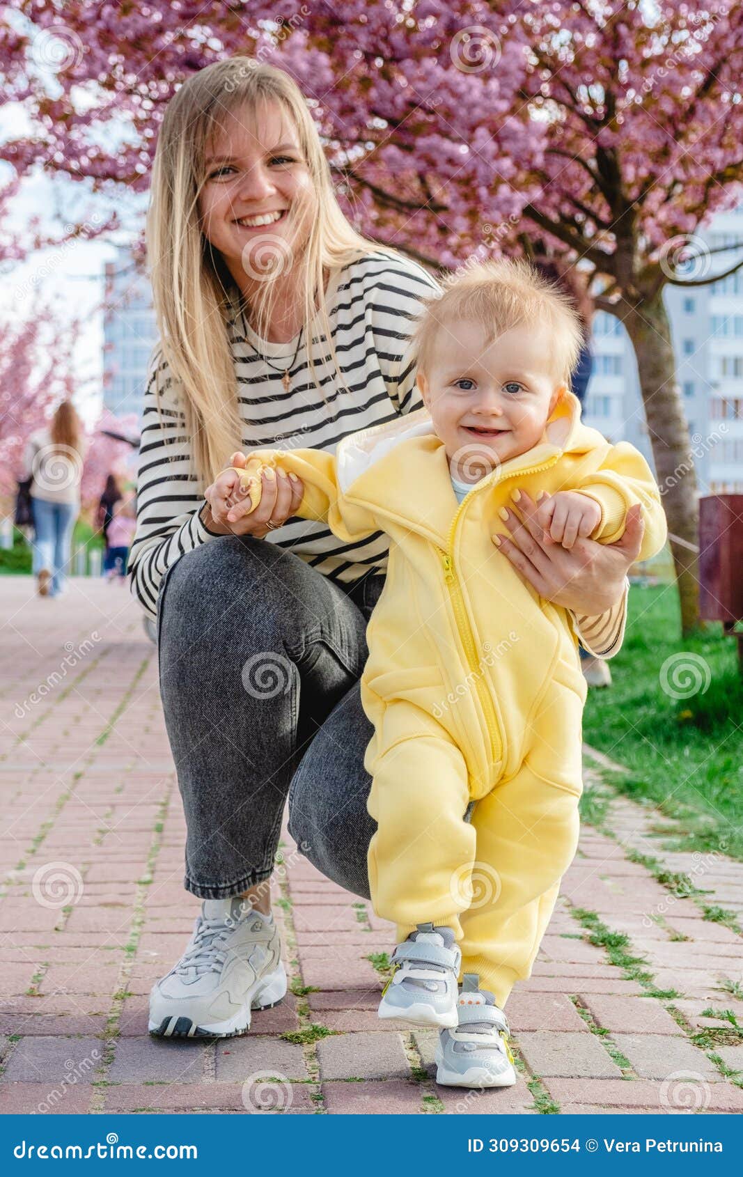 Spring Park Stroll with Mom and Son Practicing Walking Stock Photo ...
