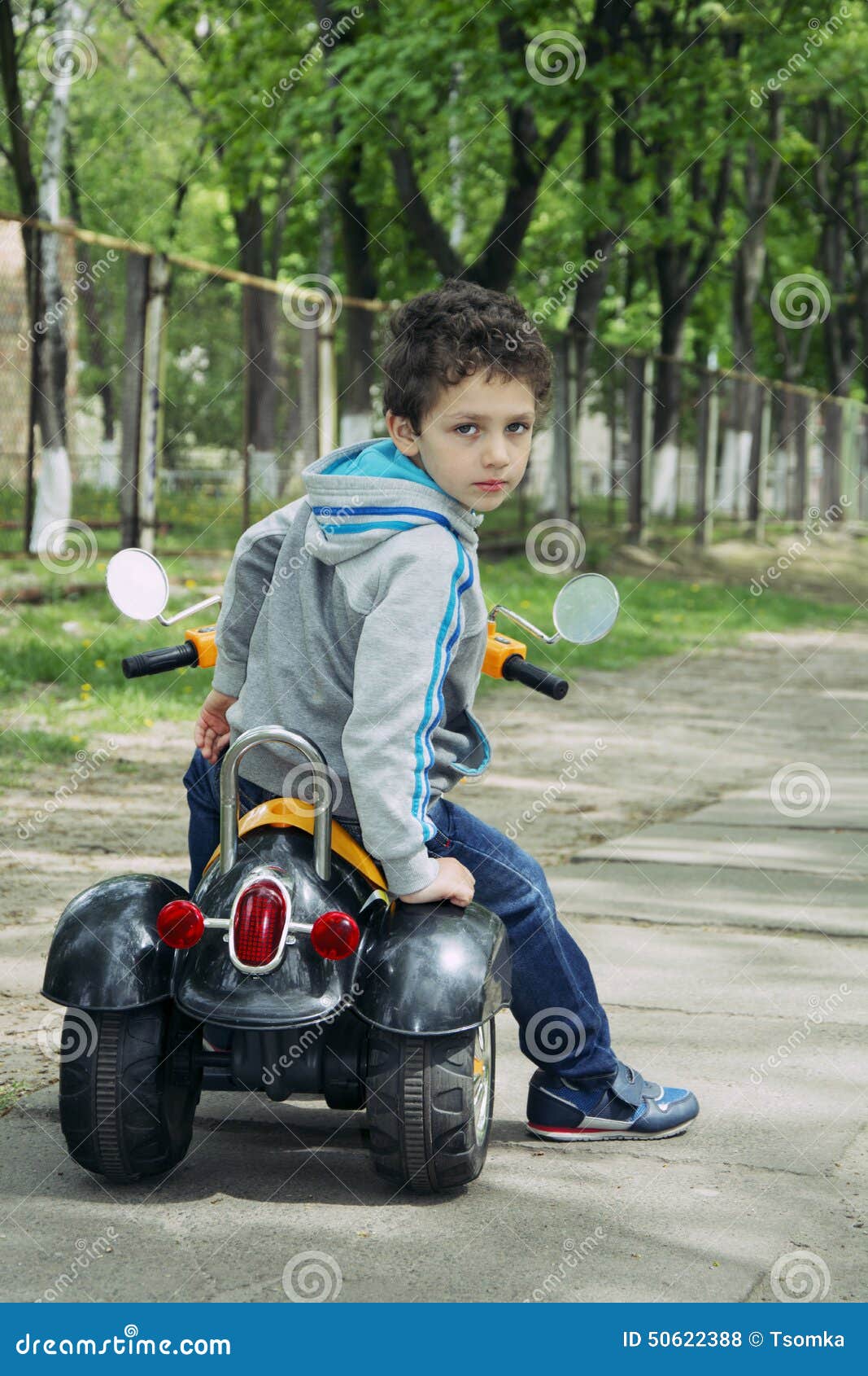 Spring on the Street a Little Boy Sitting on a Motorcycle. Stock Photo ...