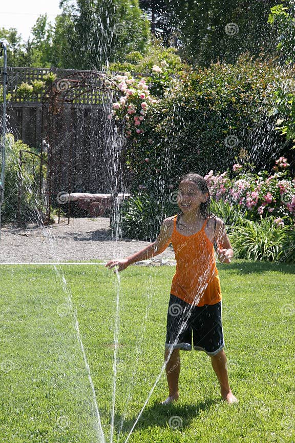 Sprinkler fun stock photo. Image of backyard, drenched - 2486546