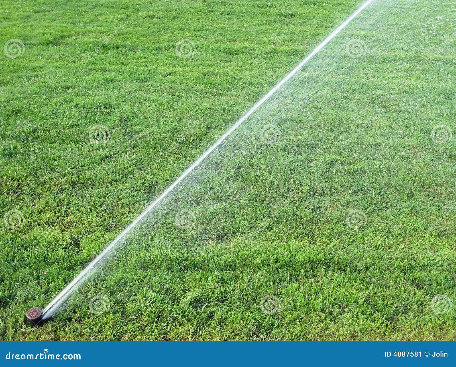 Sprinkler Spraying Water on Grass Stock Image - Image of spray, grass ...