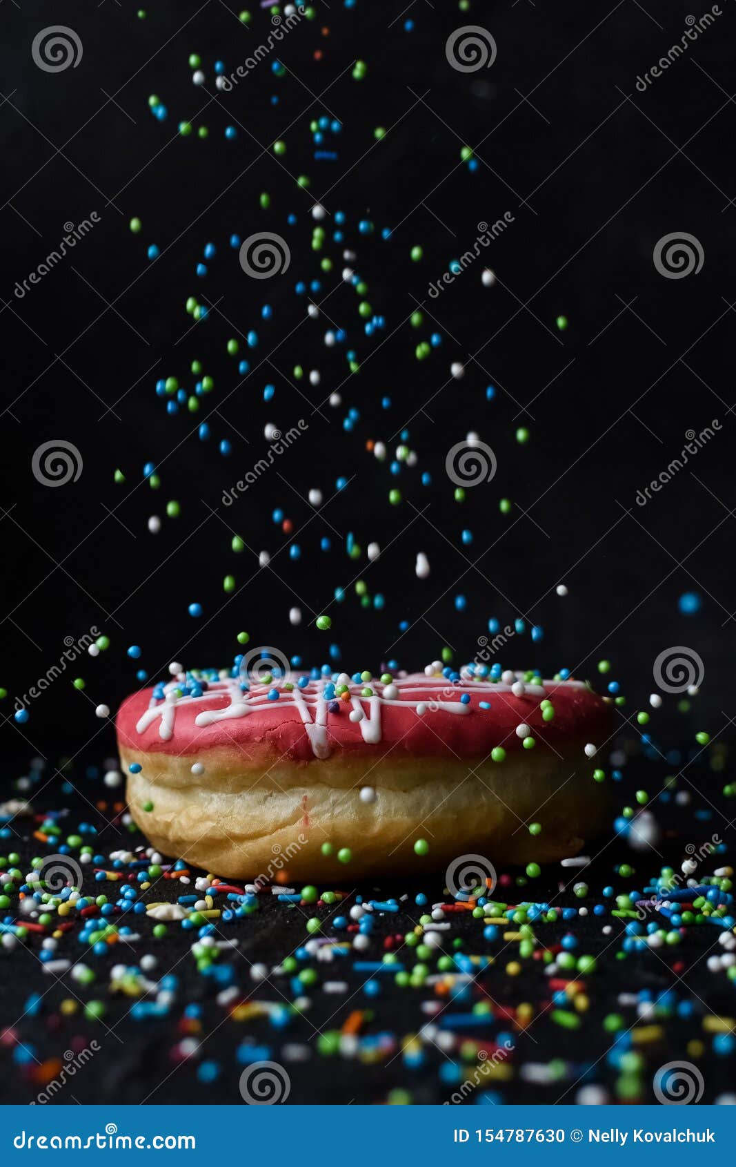 Sprinkles Falling Onto Donut Stock Photo - Image of decorated, frosting ...