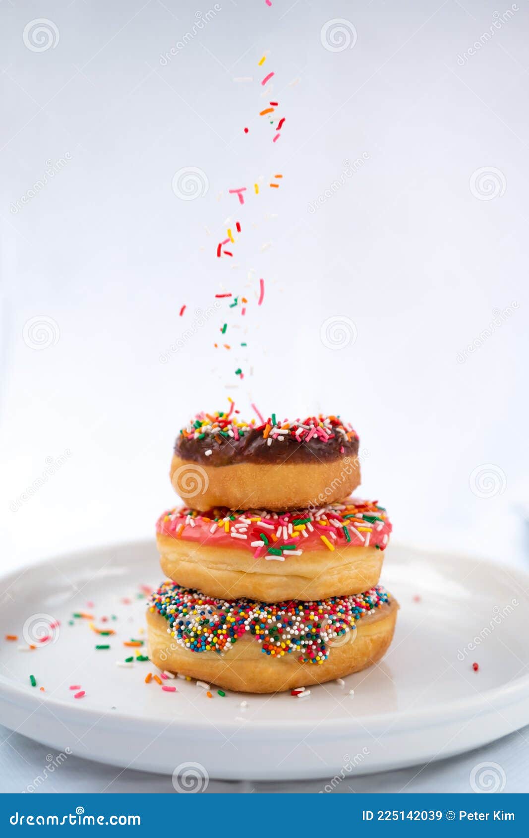 Sprinkles Falling on Some Donuts. Stock Image - Image of pink ...