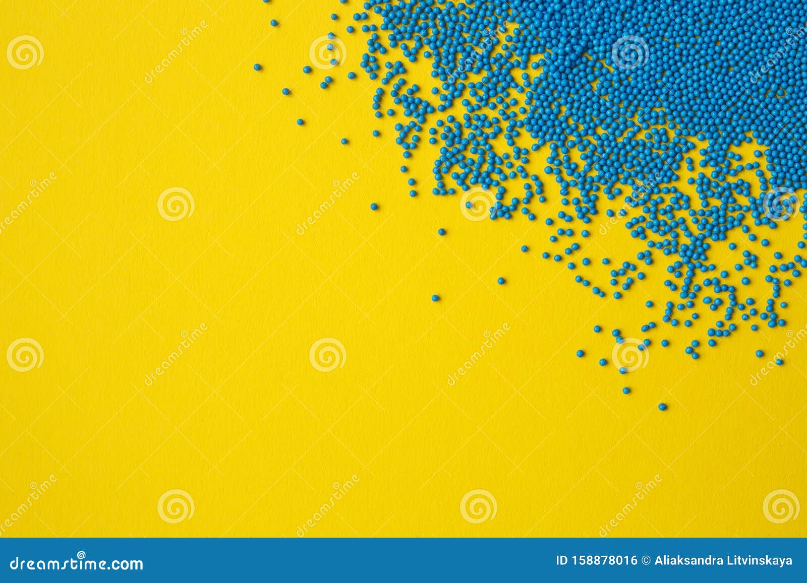 Sprinkle of Blue Balls on a Yellow Background Stock Photo - Image of ...