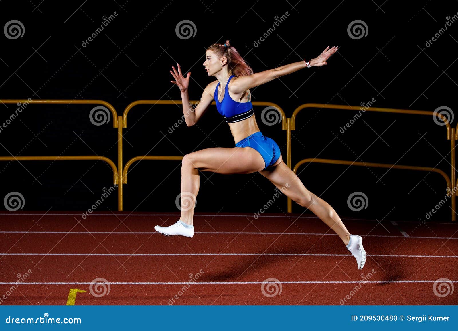 Sprinter Girl Jumps on Track Running Training Stock Photo - Image of ...