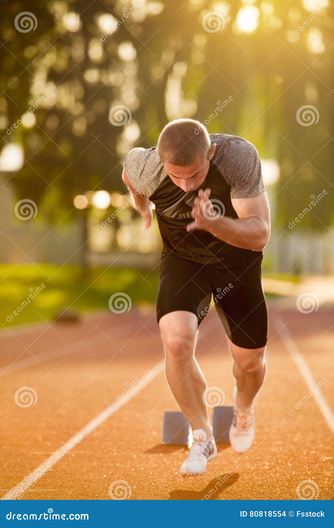 Sprinter Leaving Starting Blocks on the Running Track. Explosive Start ...