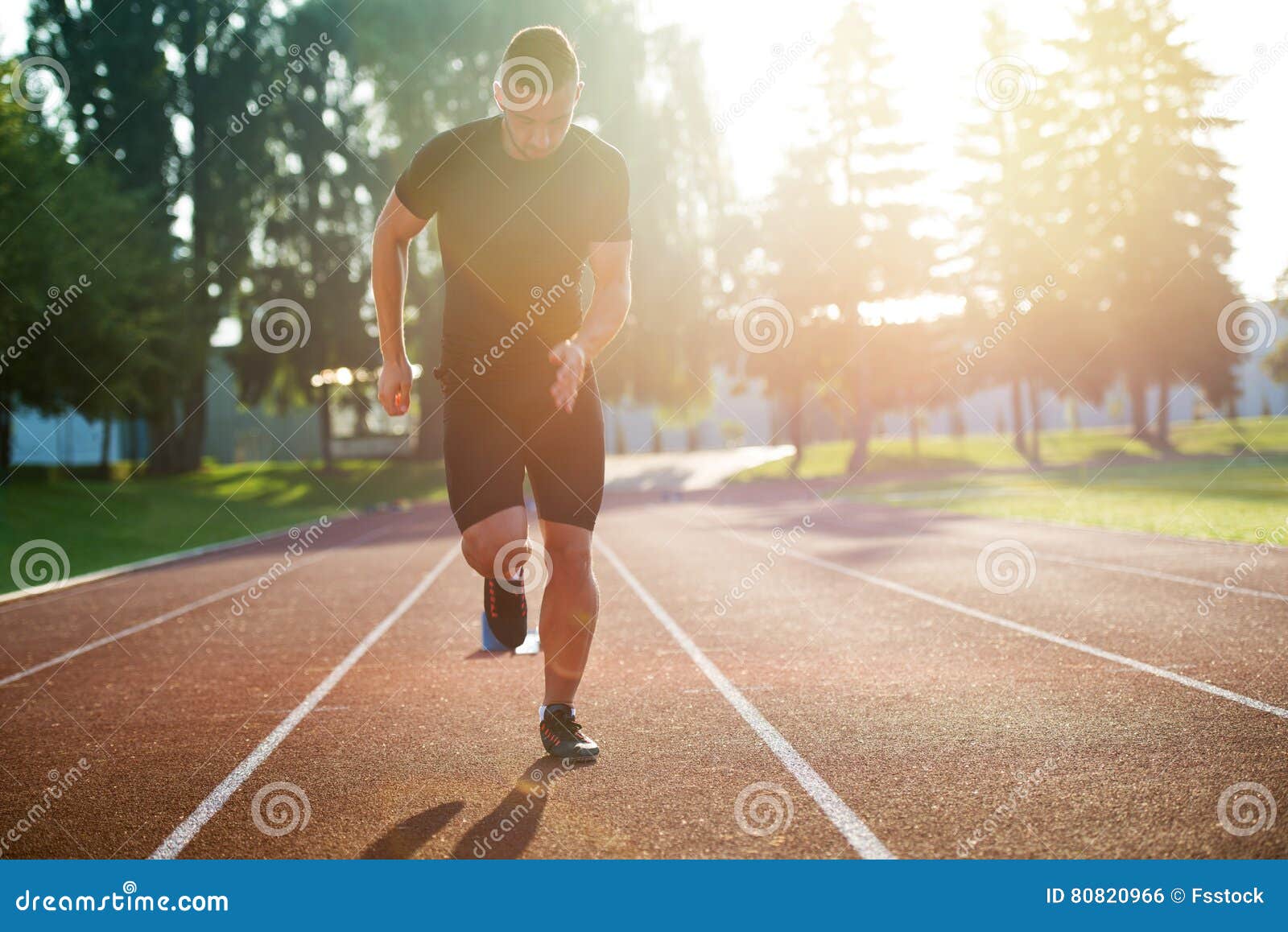 Sprinter Leaving Starting Blocks on the Running Track. Explosive Start ...