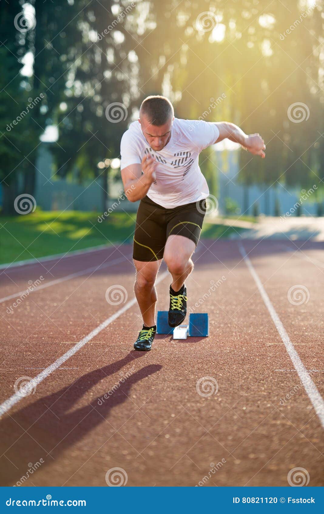 Sprinter Leaving Starting Blocks on the Running Track. Explosive Start ...