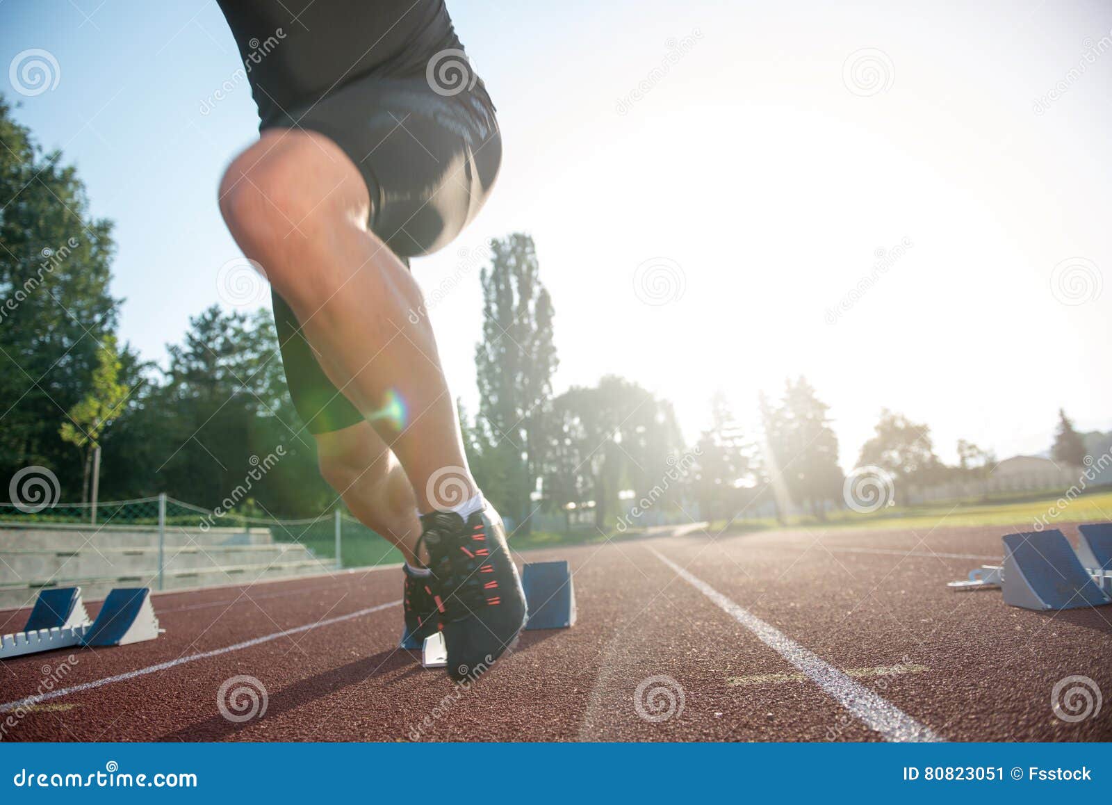 Sprinter Leaving Starting Blocks on the Running Track. Explosive Start ...