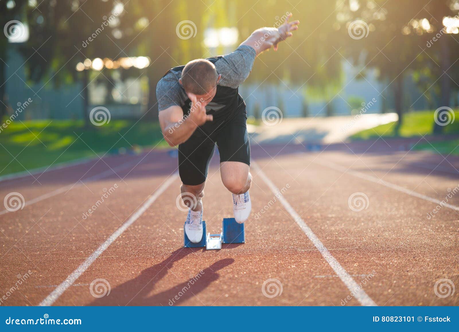Sprinter Leaving Starting Blocks On The Running Track. Explosive Start ...