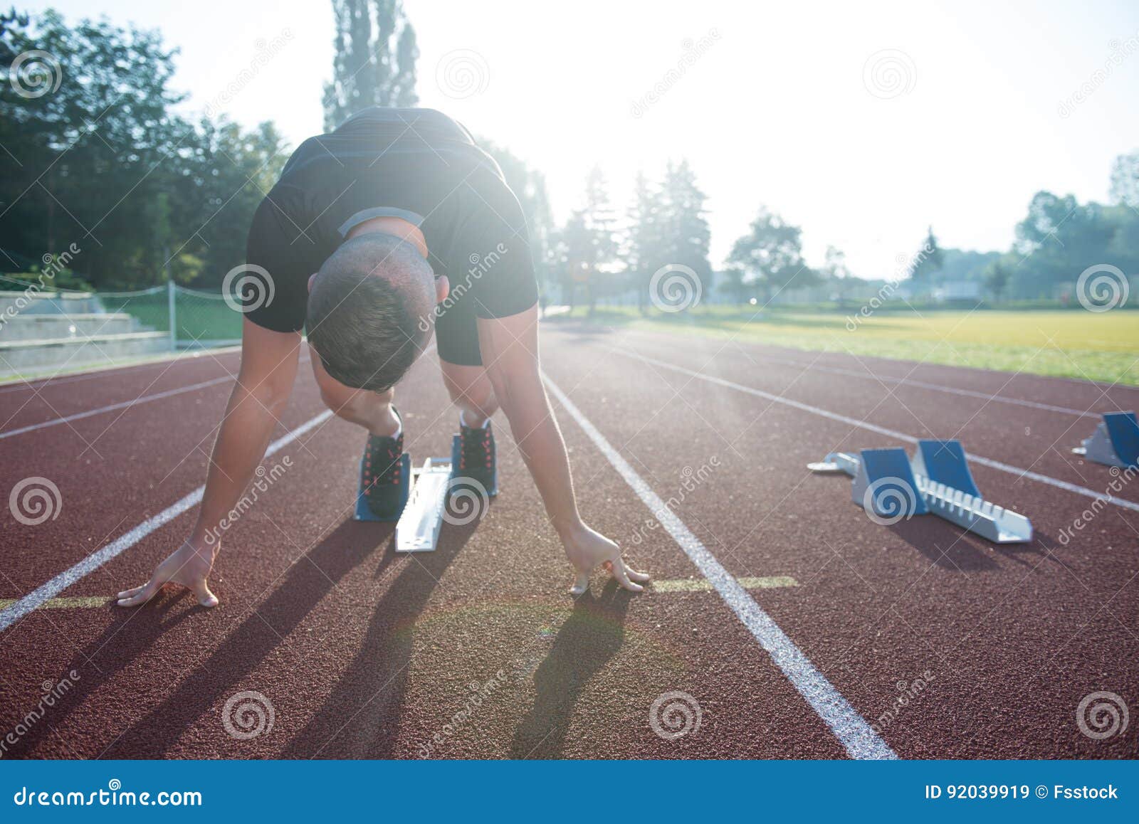 Sprinter Leaving Starting Blocks on the Running Track. Explosive Start ...