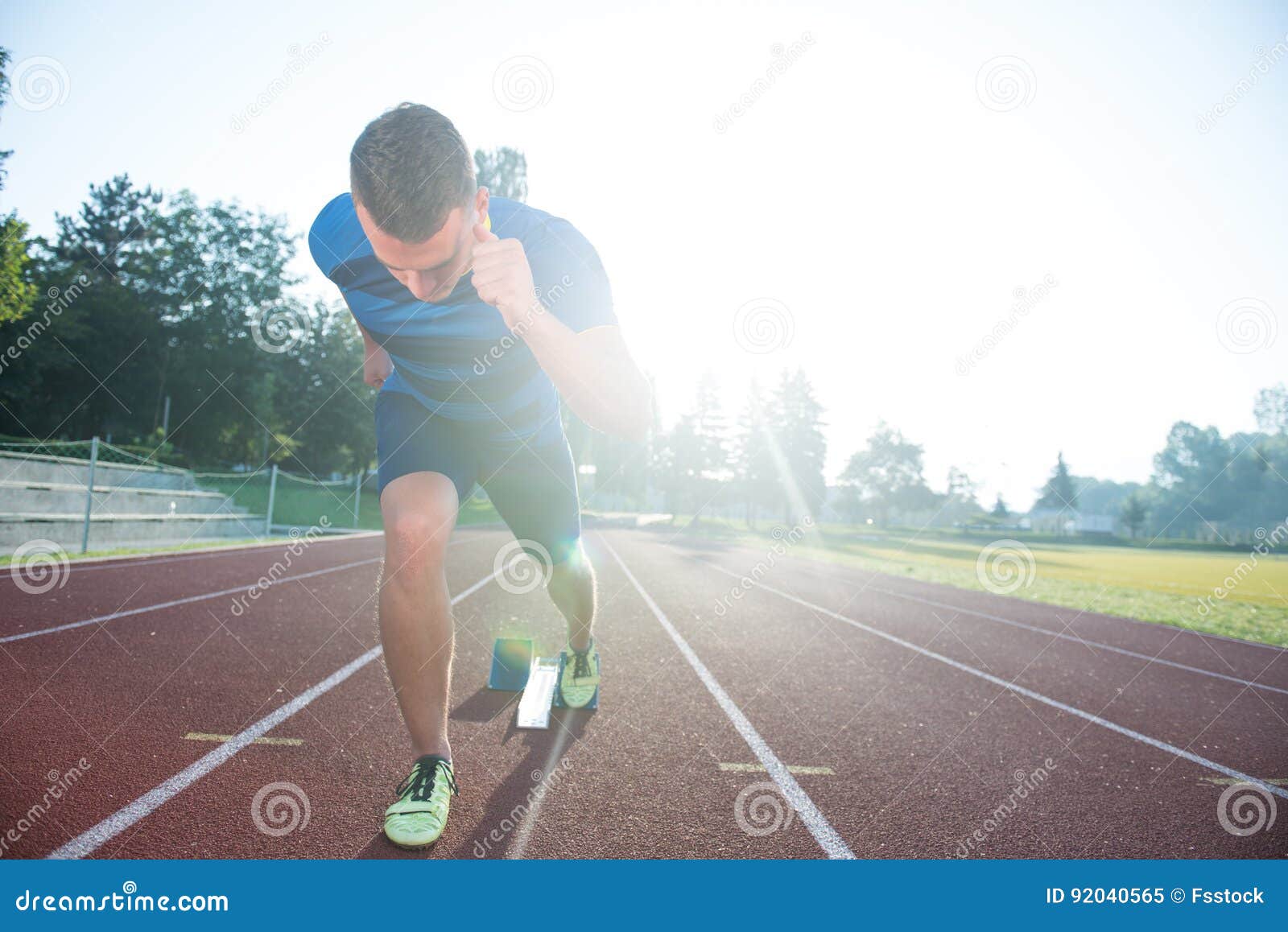 Sprinter Leaving Starting Blocks on the Running Track. Explosive Start ...