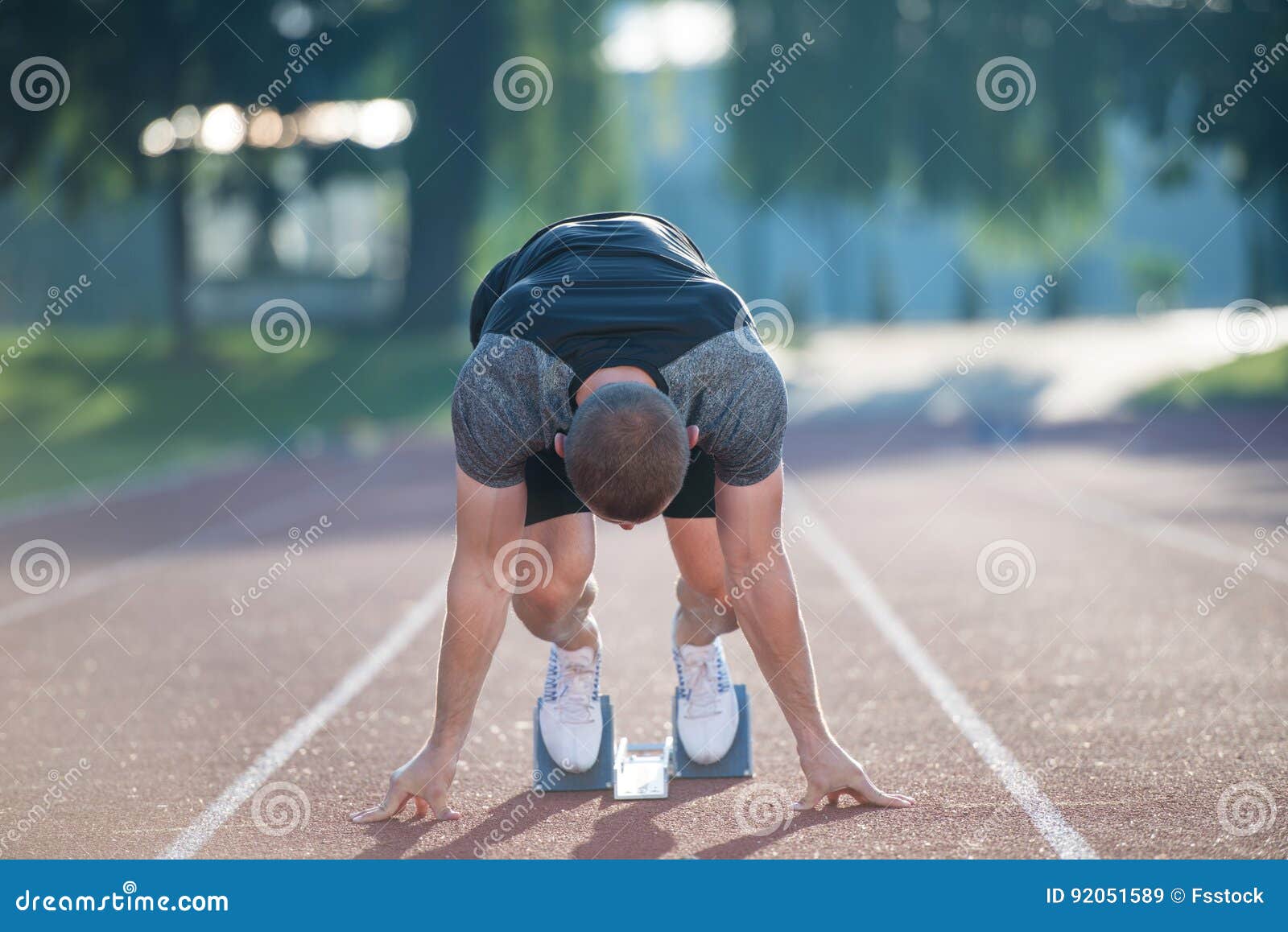 Sprinter Leaving Starting Blocks on the Running Track. Explosive Start ...