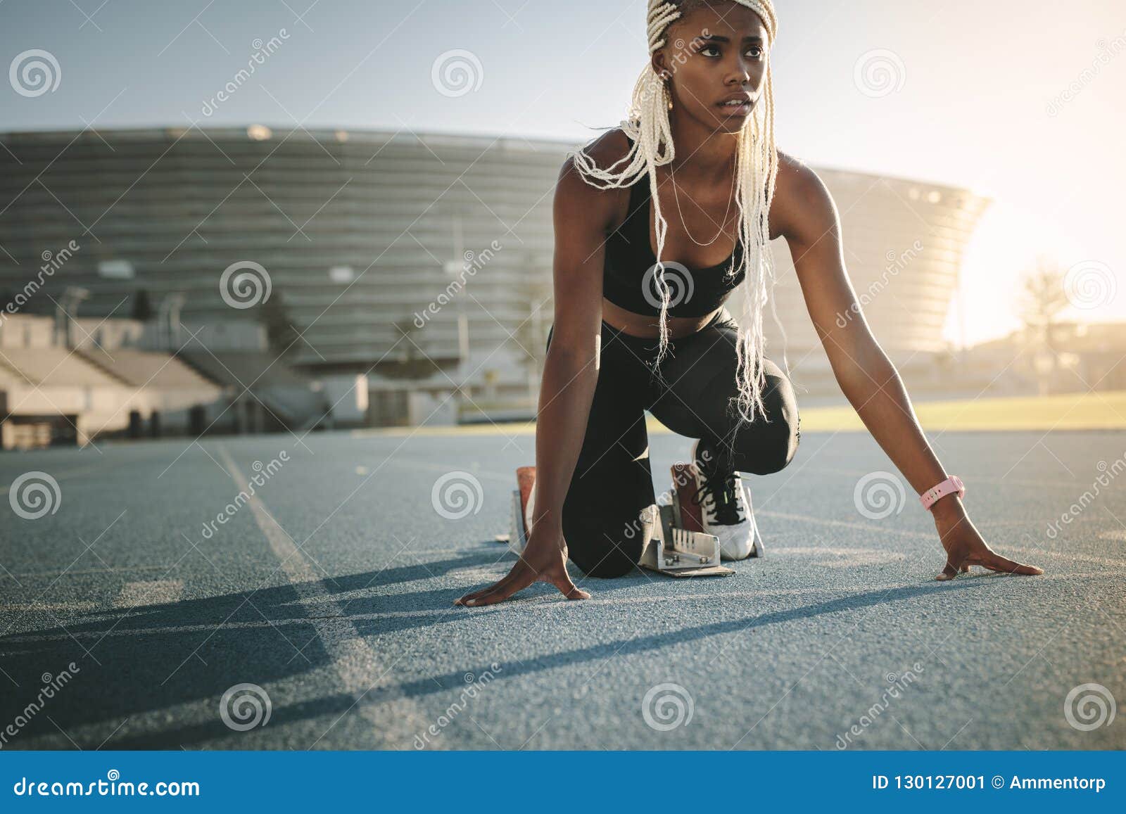 Sprinter Using a Starting Block To Start Her Sprint on a Running Stock ...