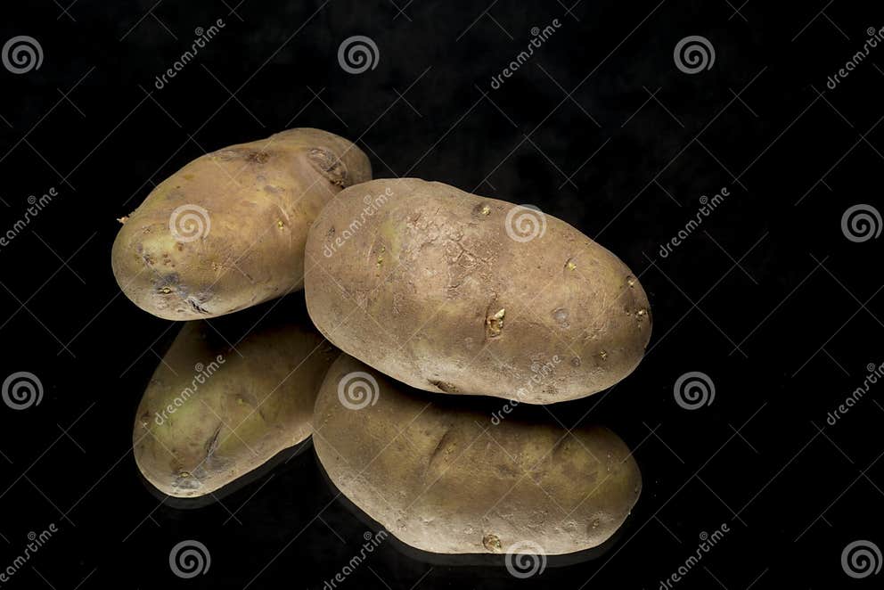 Spud Potatoes on Reflective Surface Stock Image - Image of reflective ...