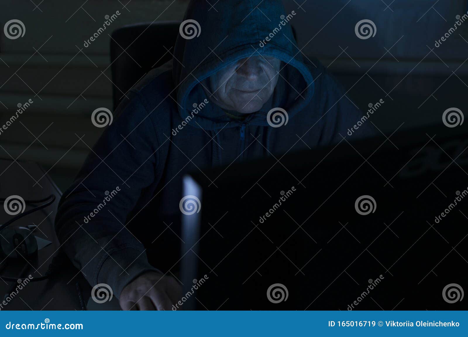 Spy Sits at the Computer at Dark Night. Blue Light from Screen on the ...