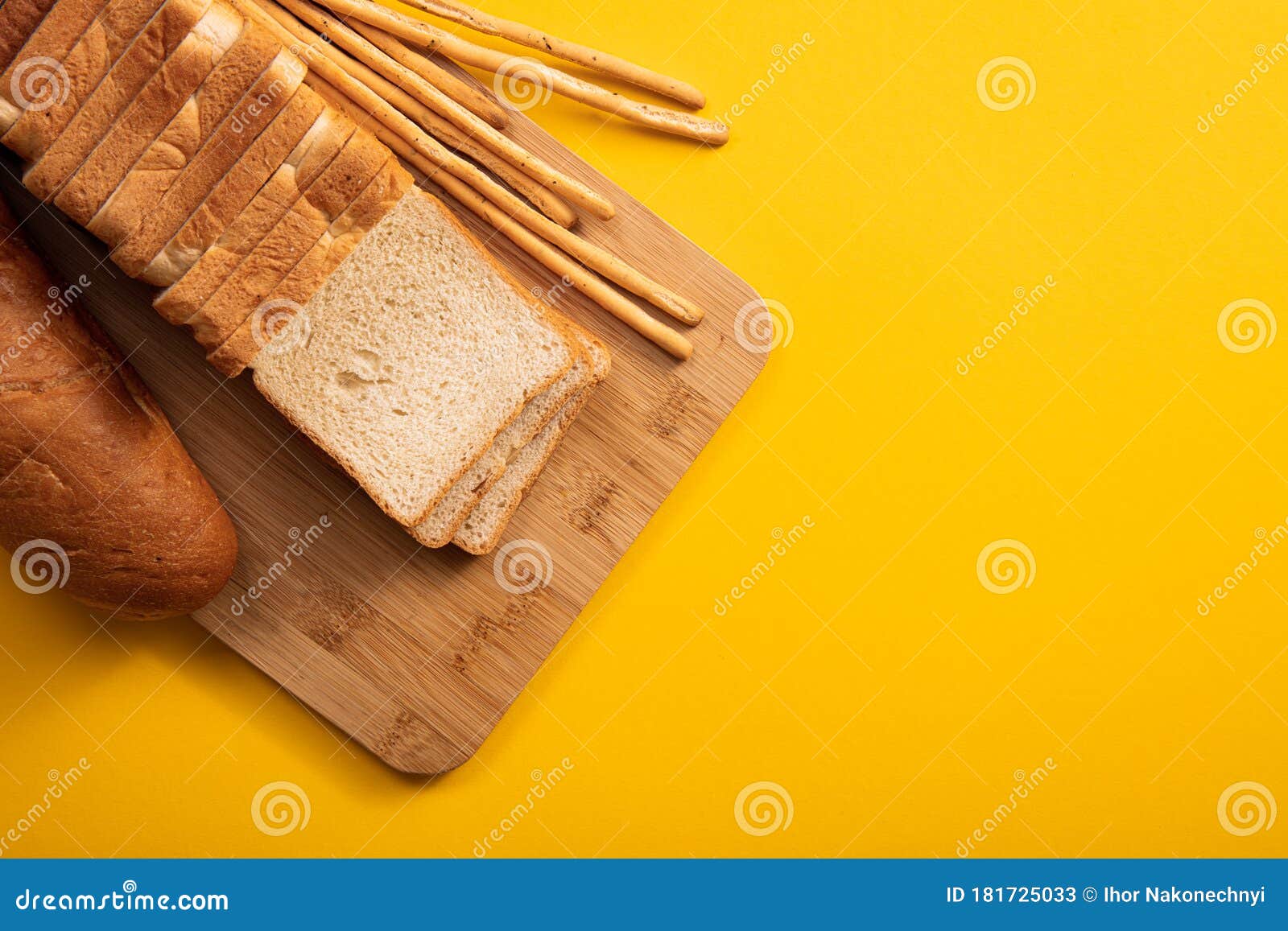 Square Bread and Breadsticks on the Table Top View. Wooden Board for ...