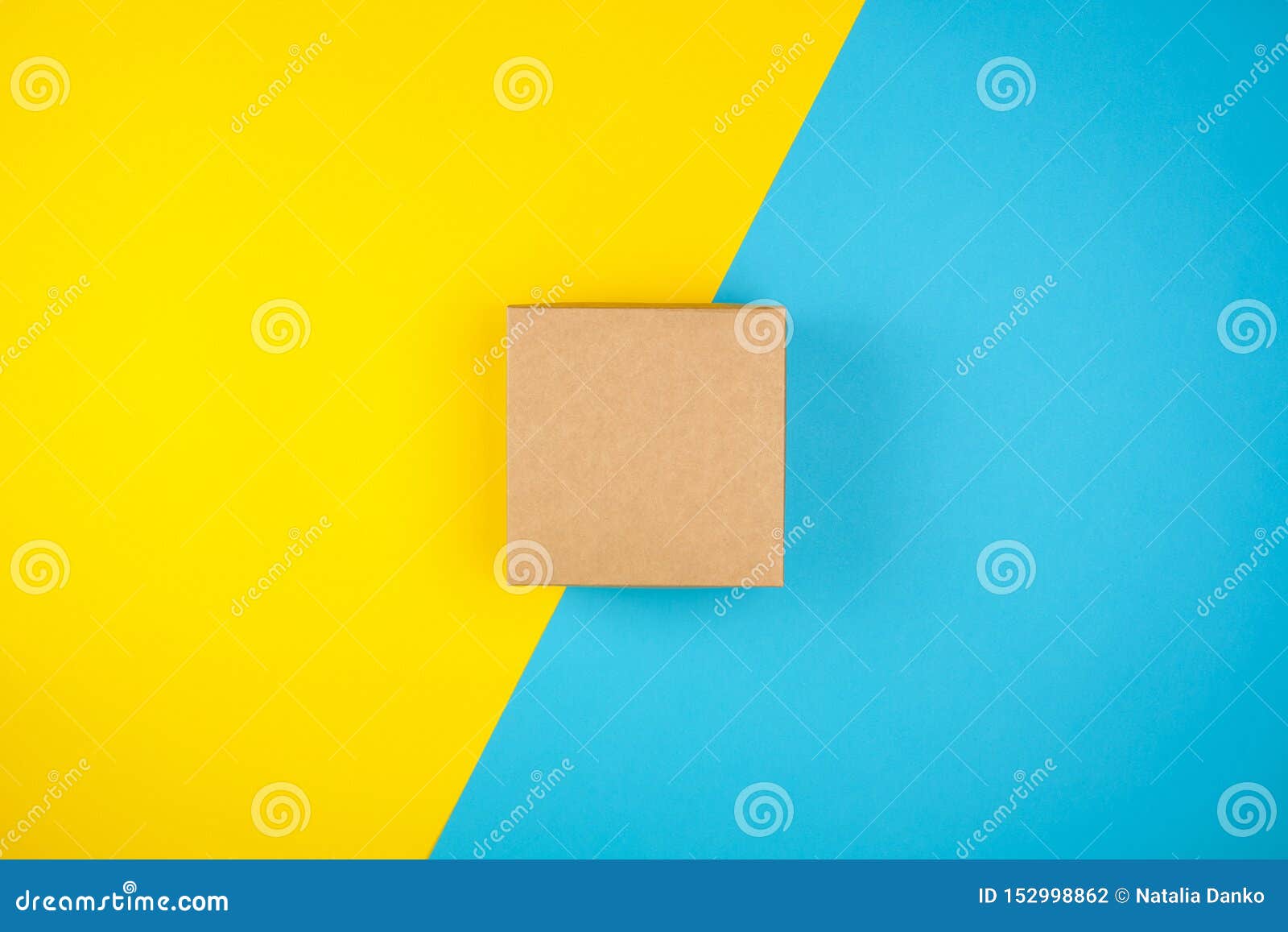 Square Brown Gift Box on a Yellow-blue Background Stock Photo - Image ...