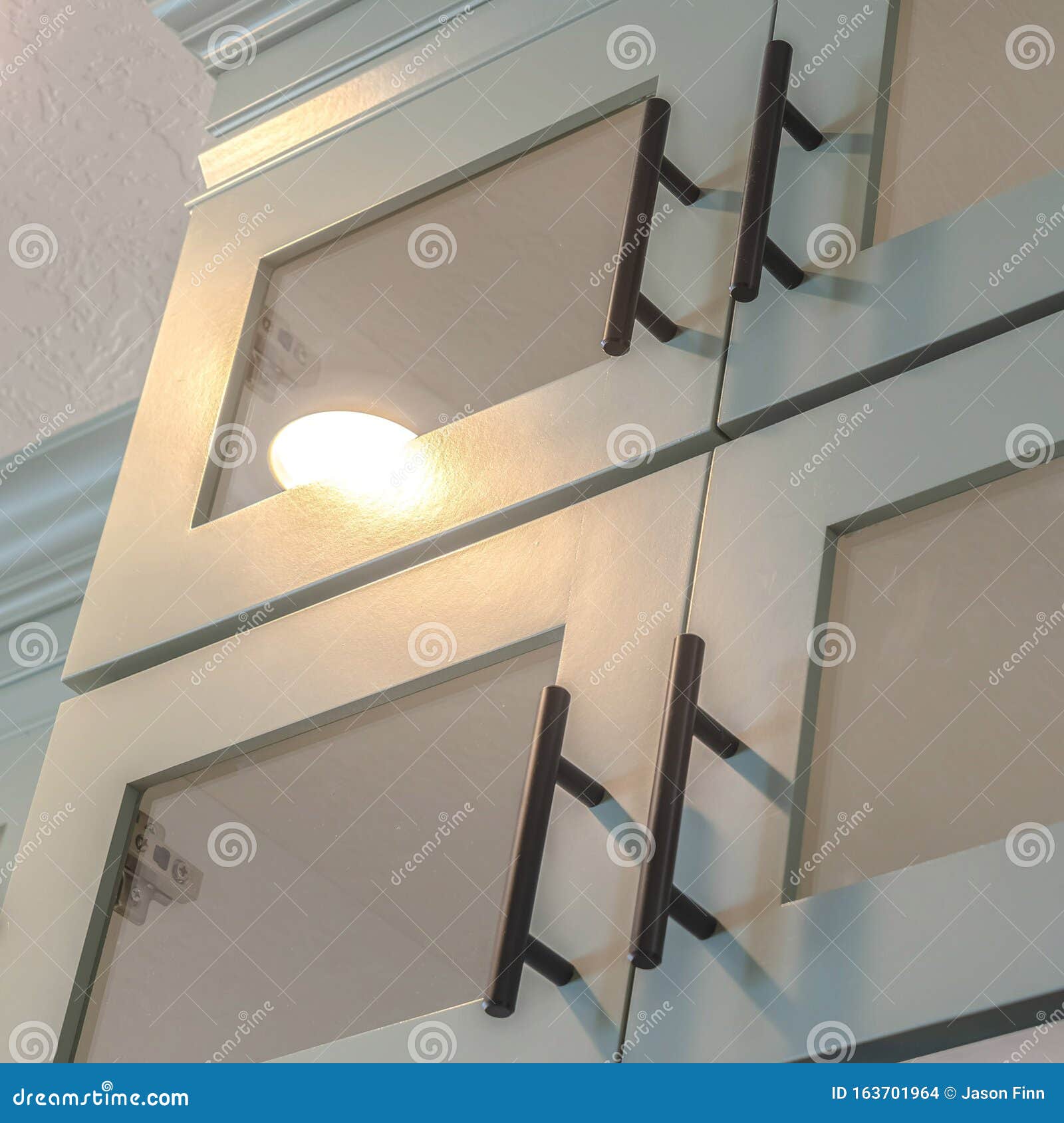 Square Close Up of Overhead Kitchen Cupboards and Handles Stock Photo ...