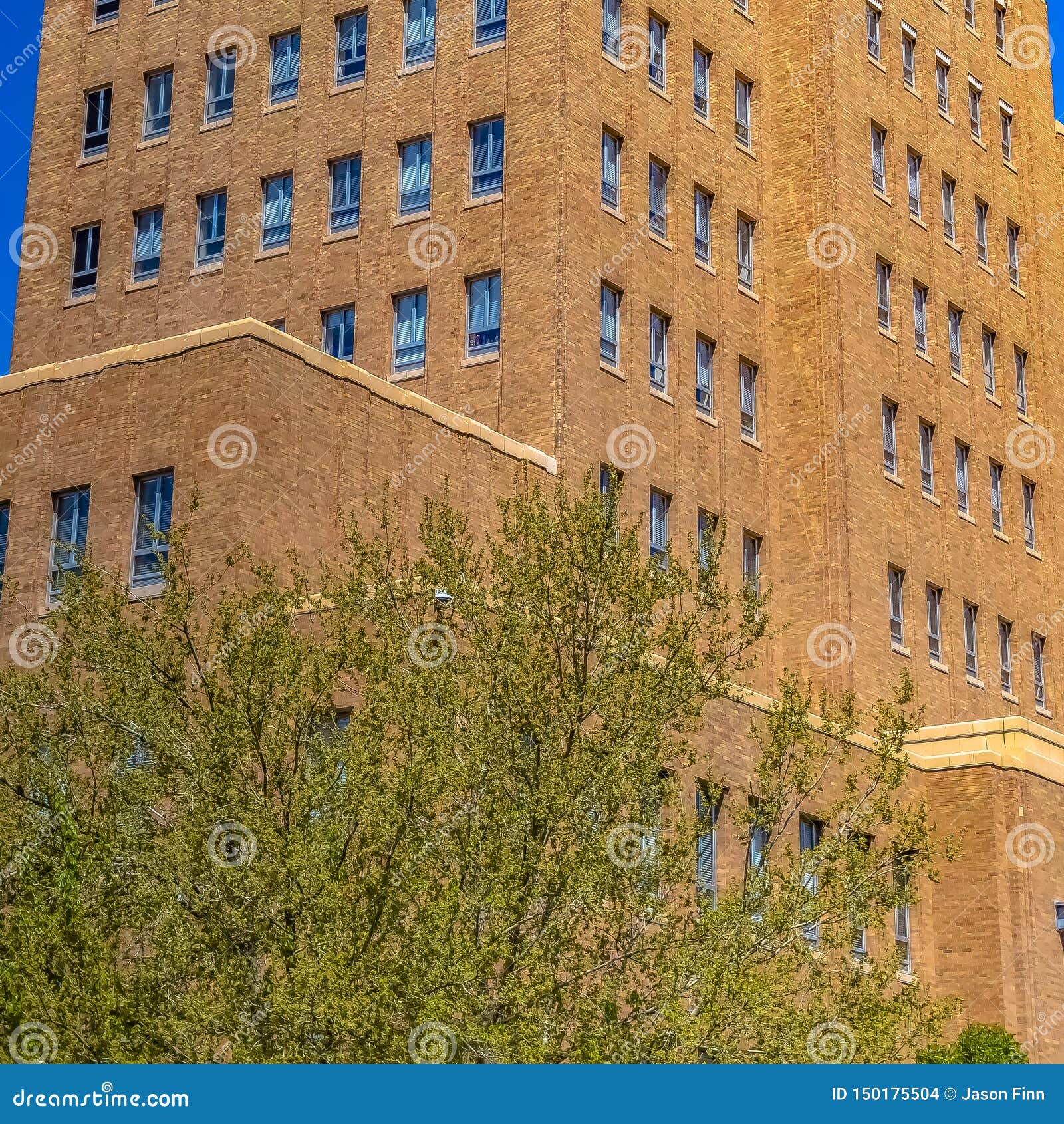 Square Frame Building Exterior with Brick Wall and Rectangular Windows ...