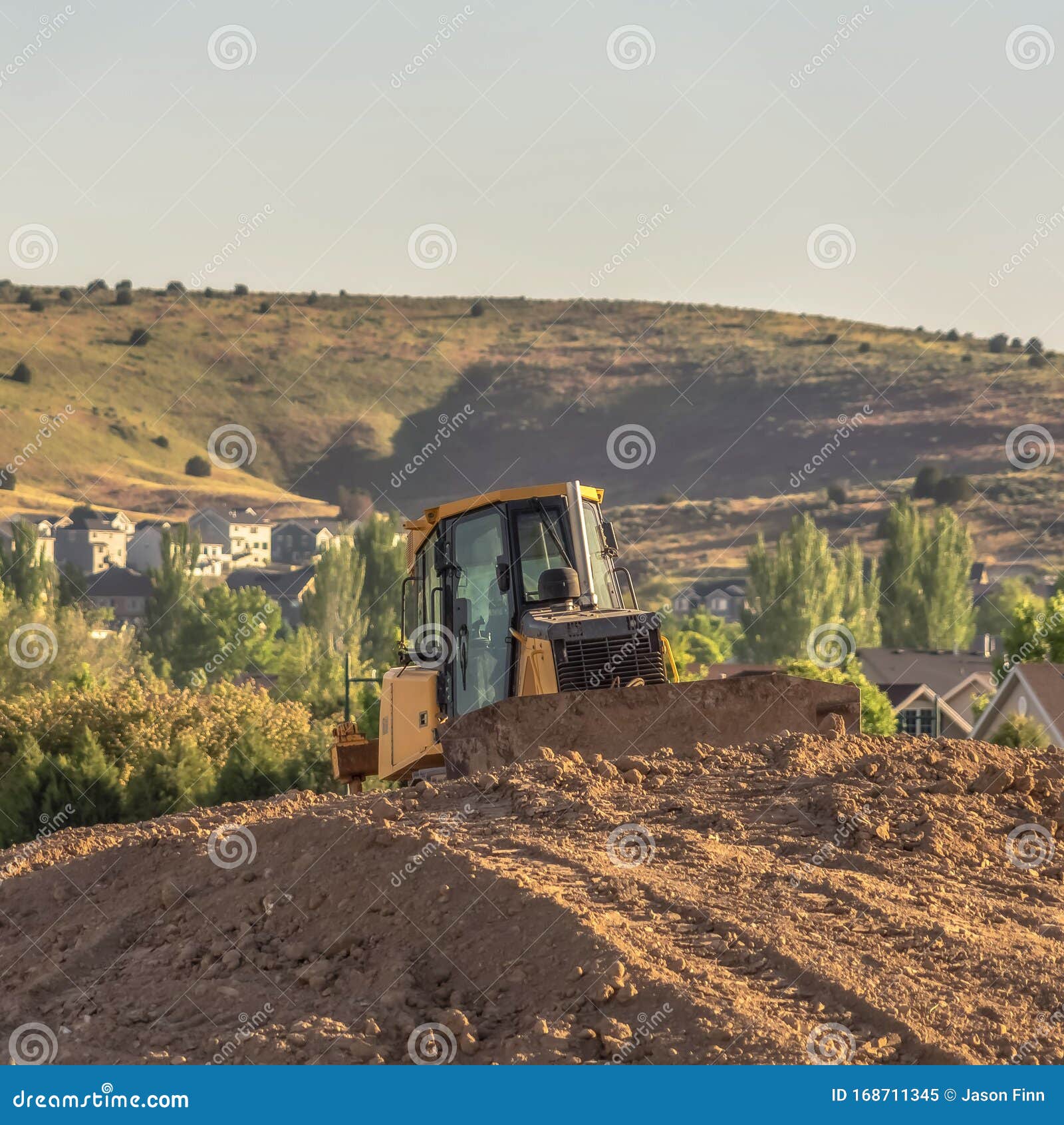 Square Frame Bulldozer on a Mound of Soil at a Construction Site ...