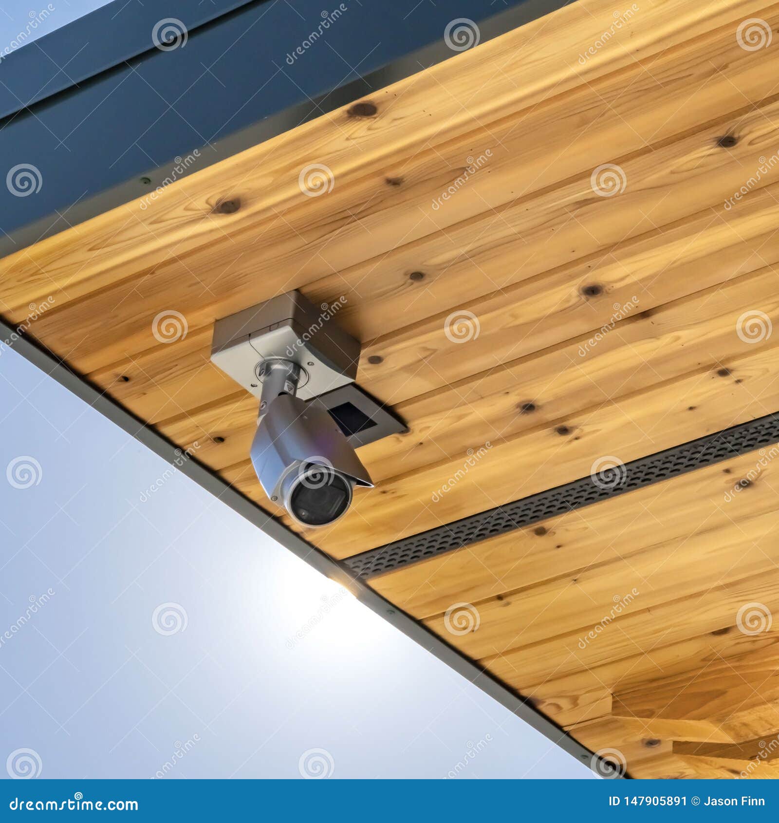 Square Home with Security Camera Installed on the Wooden Underside of ...