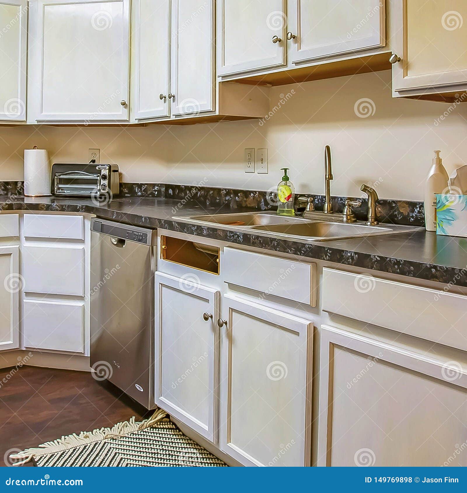 Square Interior of a Kitchen with White Cabinets and Counters Built ...