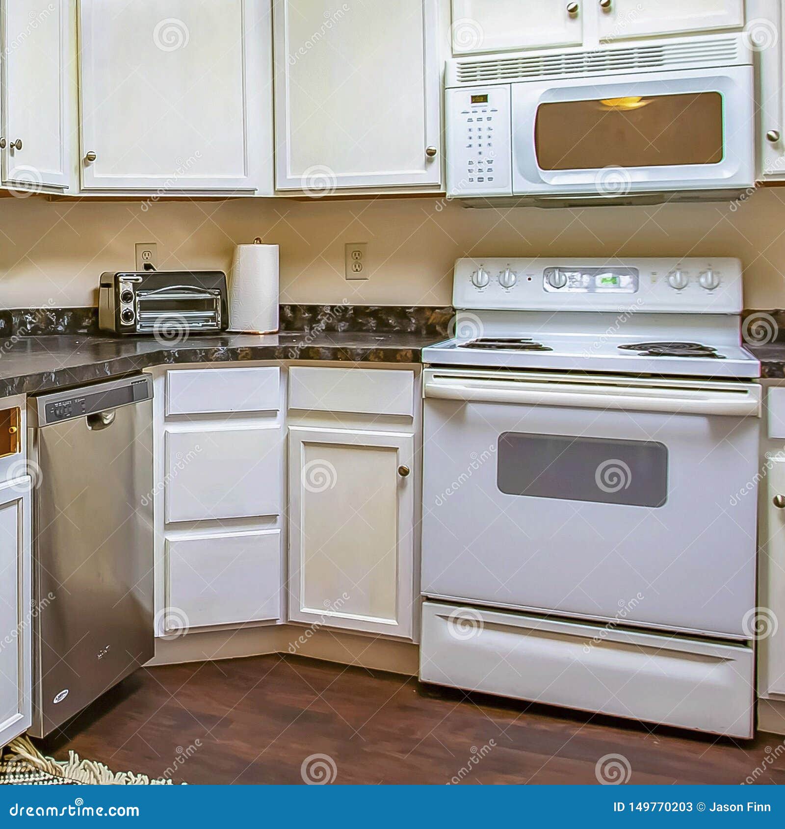 Square Interior of a Kitchen with White Cabinets and Counters Built ...
