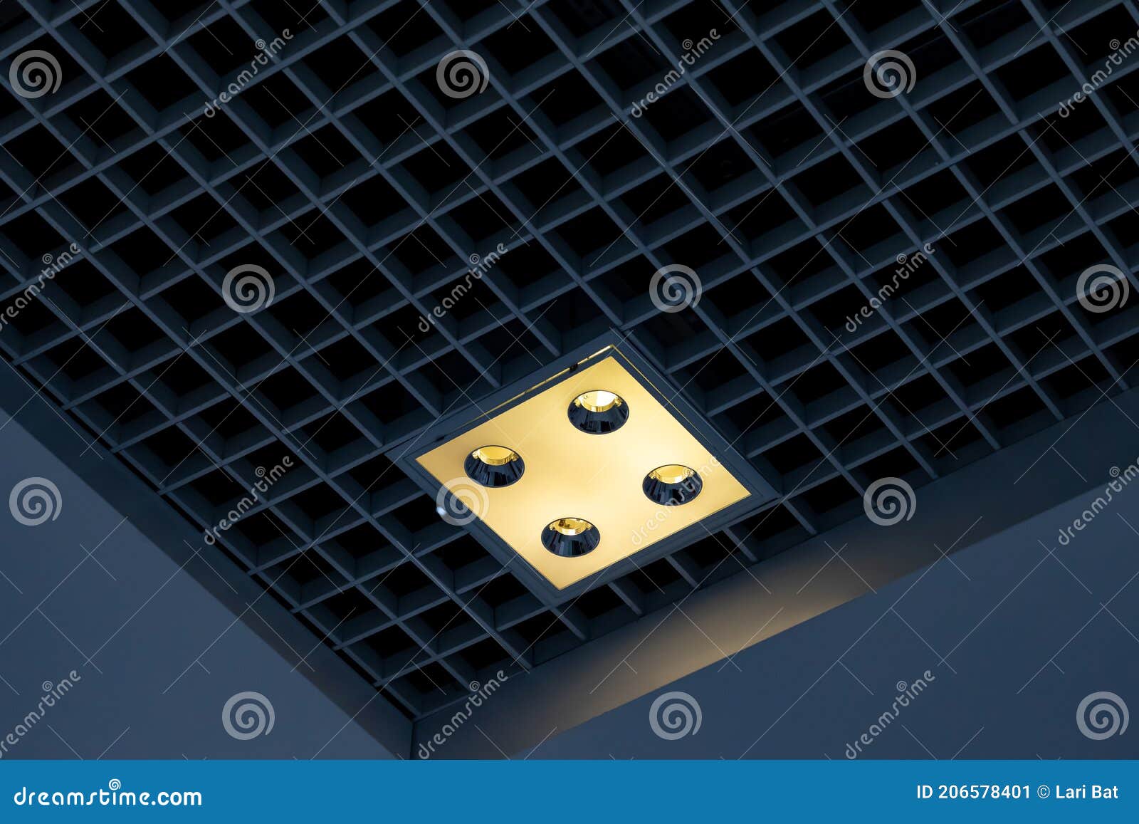Square Lighting Fixture with Four Lamps on the Ceiling of an Commercial ...