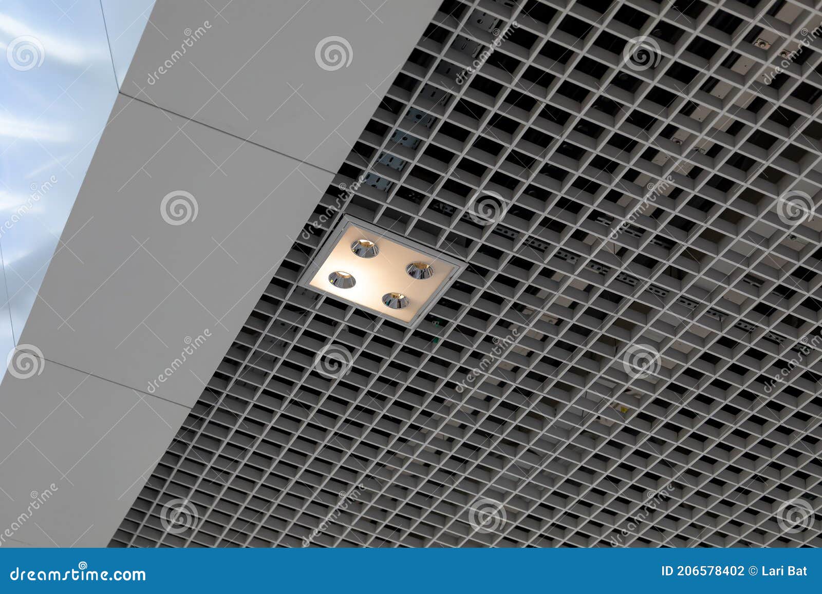 Square Lighting Fixture with Four Lamps on the Ceiling of an Commercial ...
