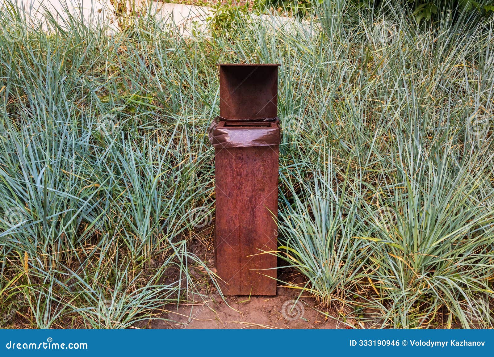 Square Metal Trash Can. Rectangular Rusty Trash Can Stands on the ...