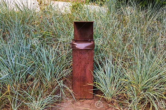 Square Metal Trash Can. Rectangular Rusty Trash Can Stands on the ...