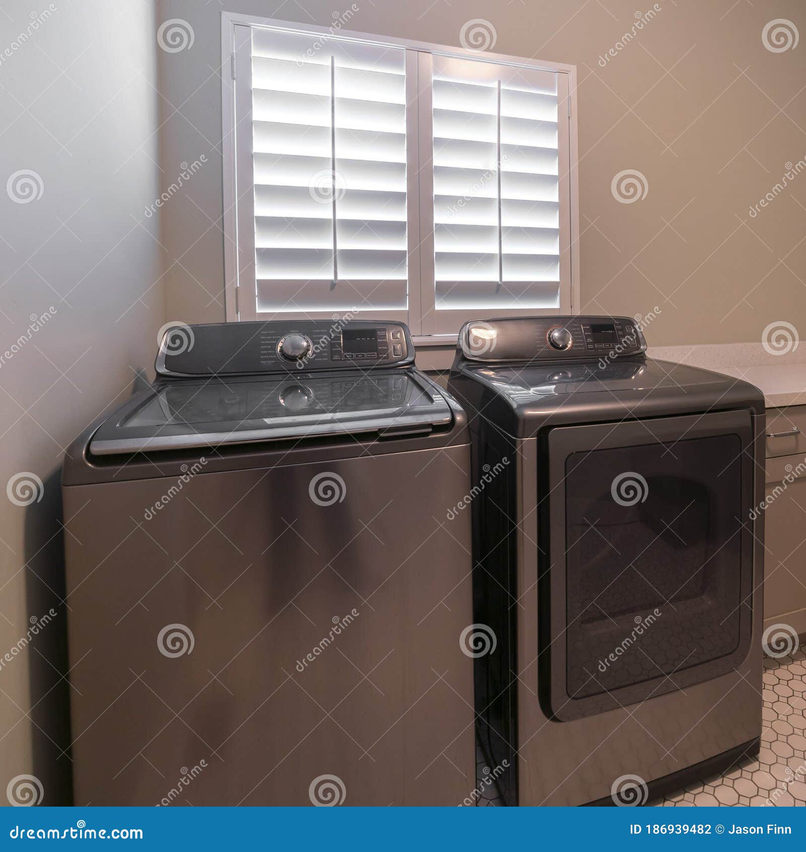 Square Metallic Washing Machine and Dryer in a Laundry Stock Photo ...