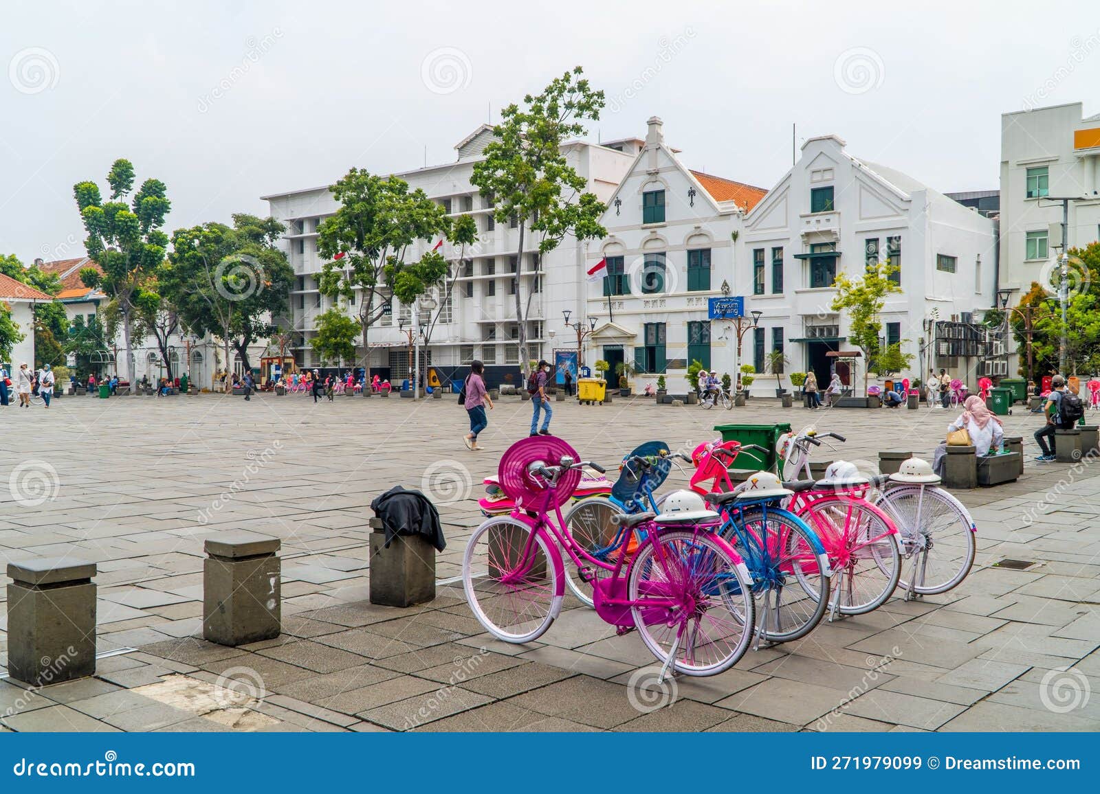 Square with Multiple Bikes Parked on it and a Group of People Walking ...