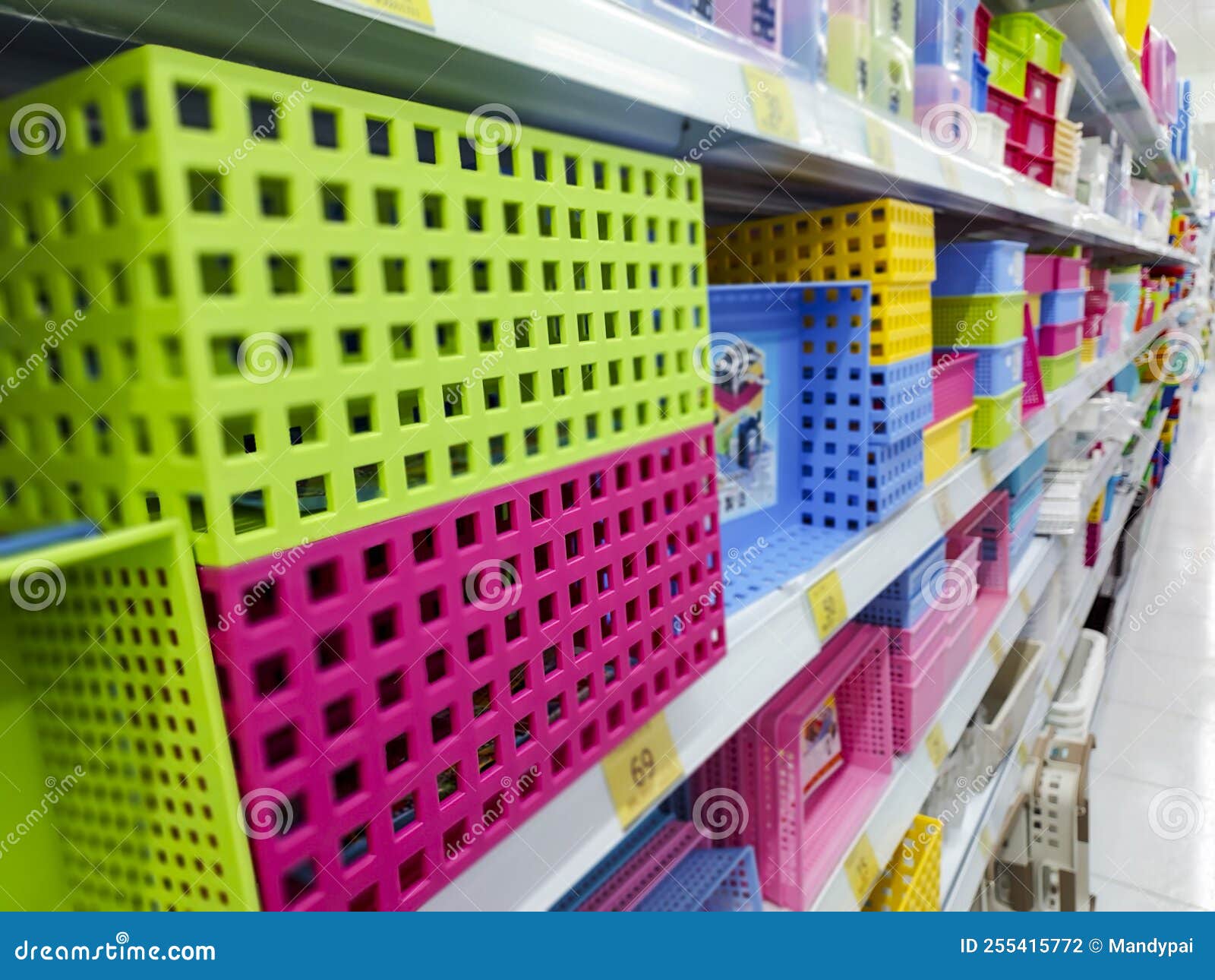 Square Plastic Storage Baskets of Various Colors on the Shelf in a ...