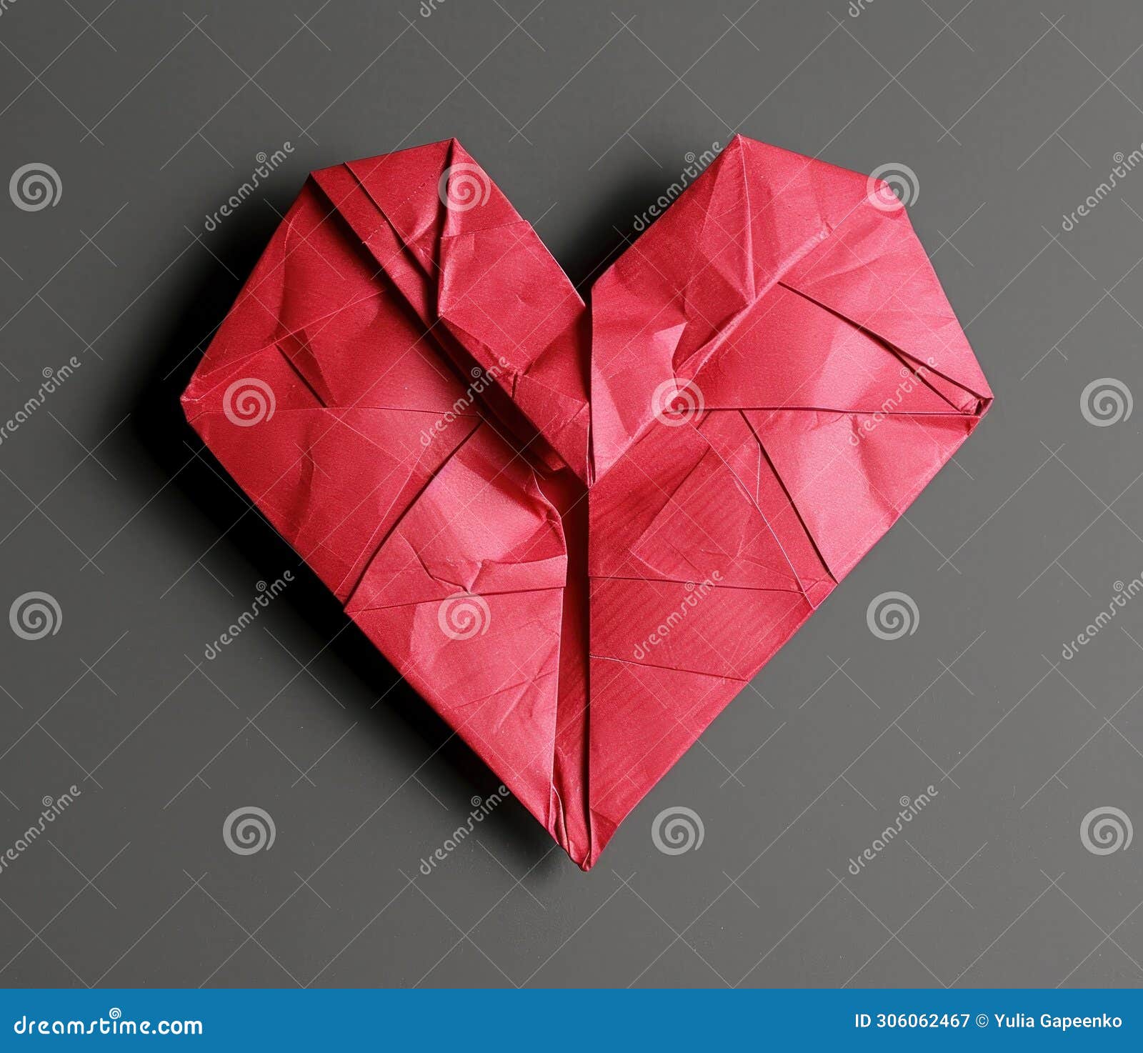 A Square of Red Origami Paper that Has Been Folded into a Heart Shape ...