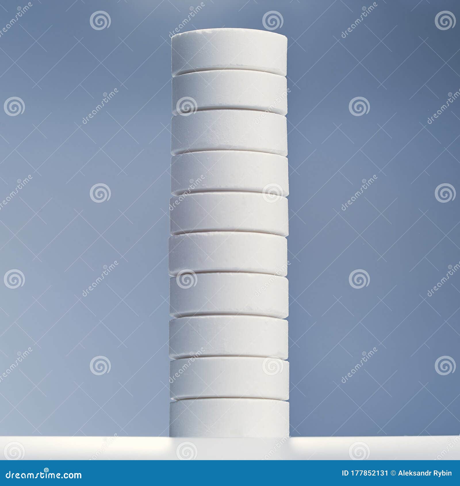 Stack of White Capsules Stands on a White Table Isolated on Gray ...