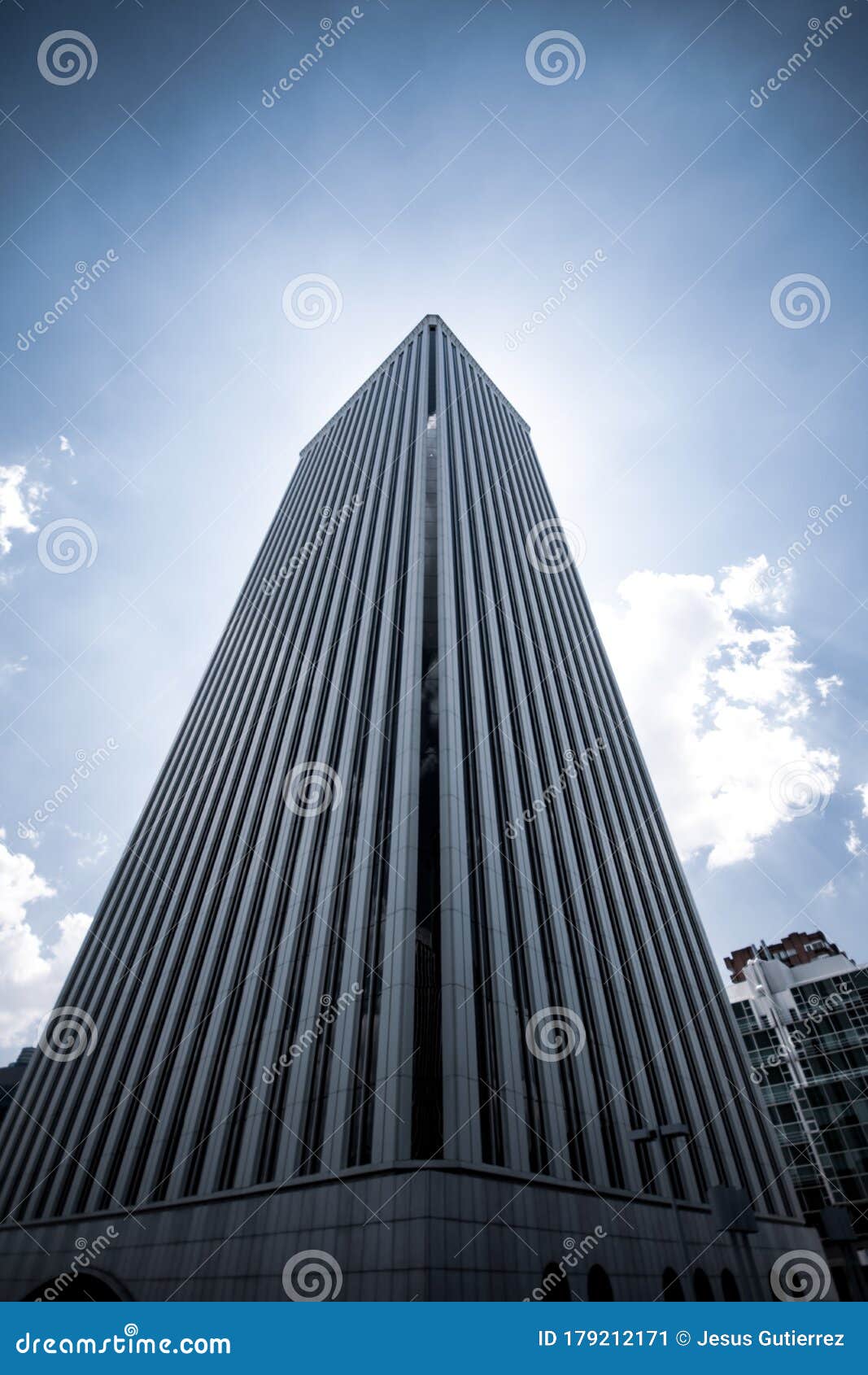 Square Skyscraper Backlit with Glimpses of the Sun Coming Out from ...