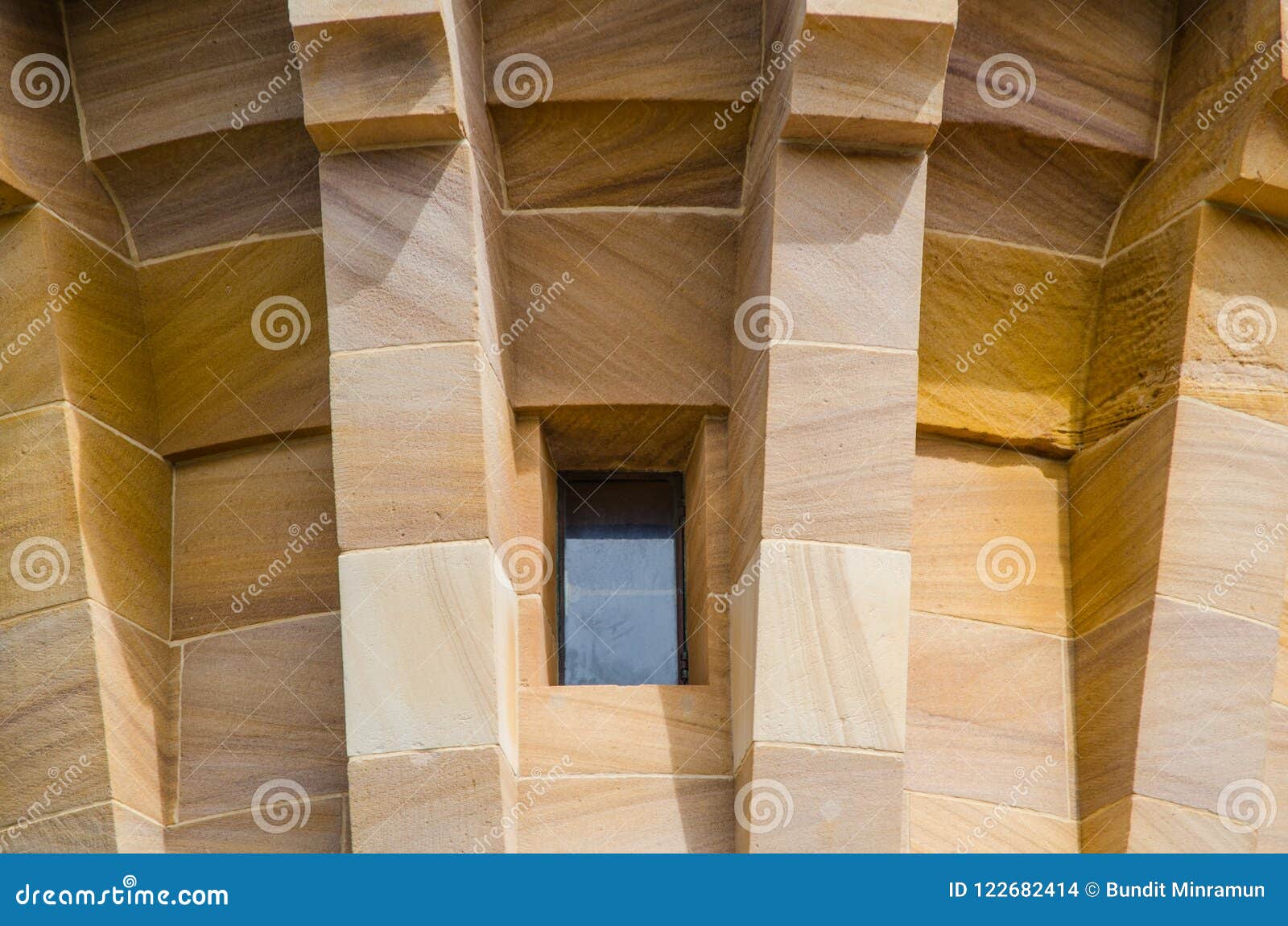 Square Small Glass Window on the Design Pattern of Brown Sandstone Wall ...